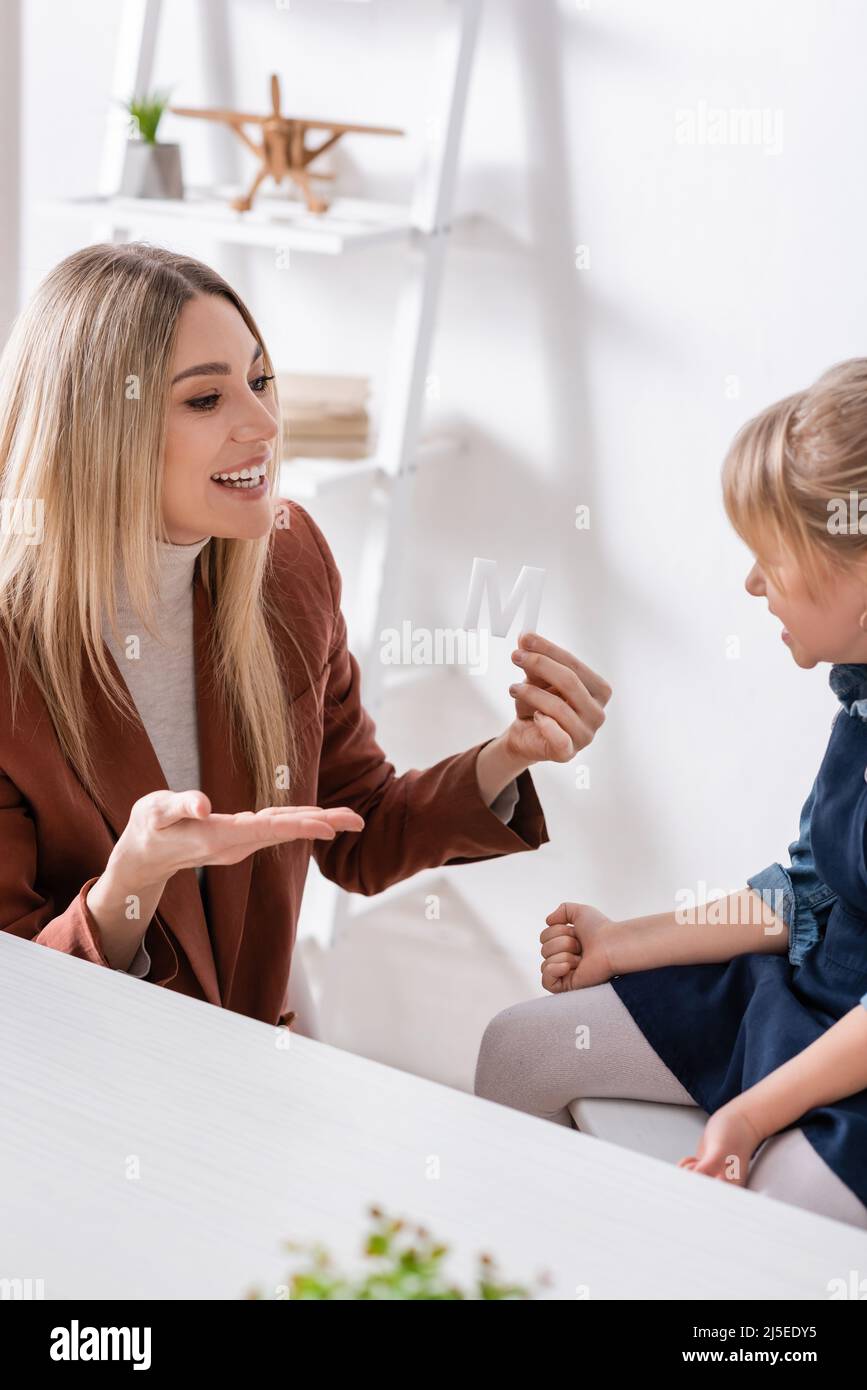 Teacher pointing to letter in classroom hi-res stock photography and ...