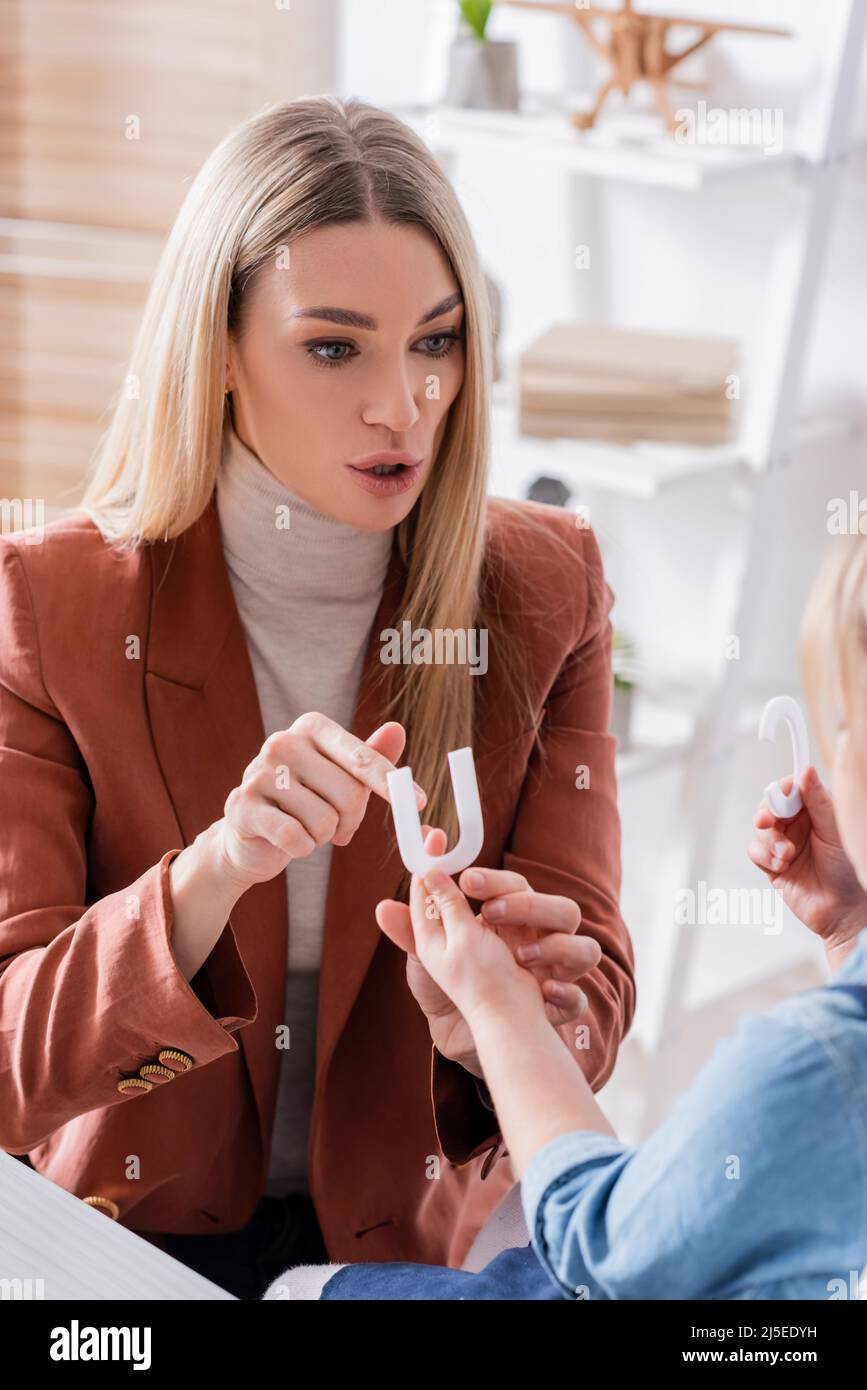 Teacher pointing to letter in classroom hi-res stock photography and ...