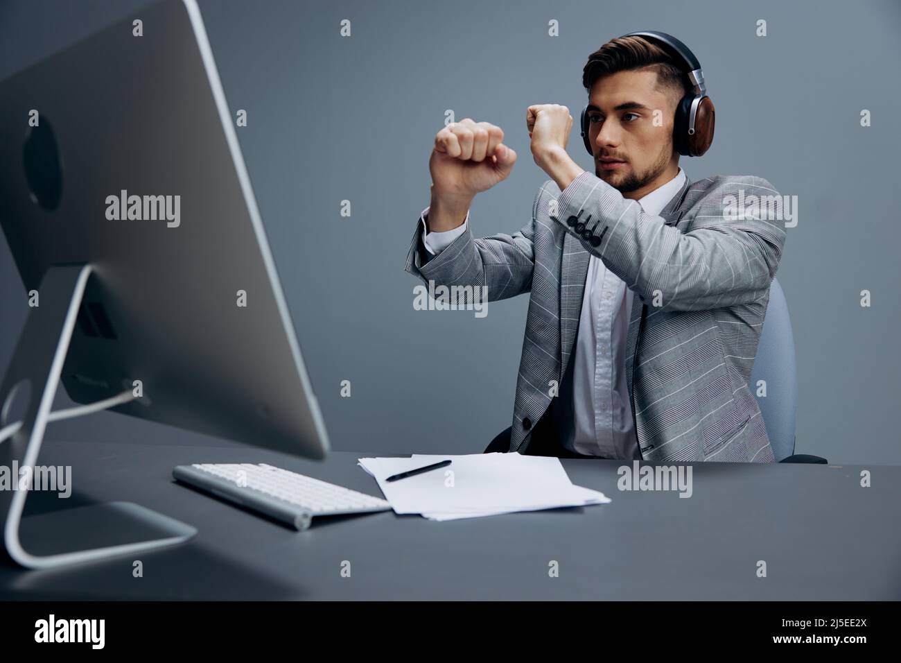 manager working at the computer in headphones in the office Gray ...