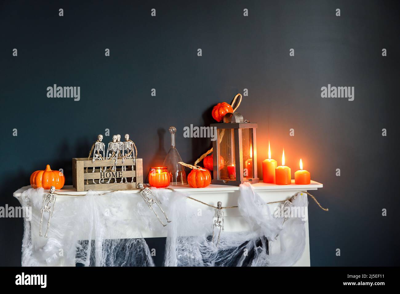 Halloween home decoration. Plastic toy skeletons in a wooden box on a ...