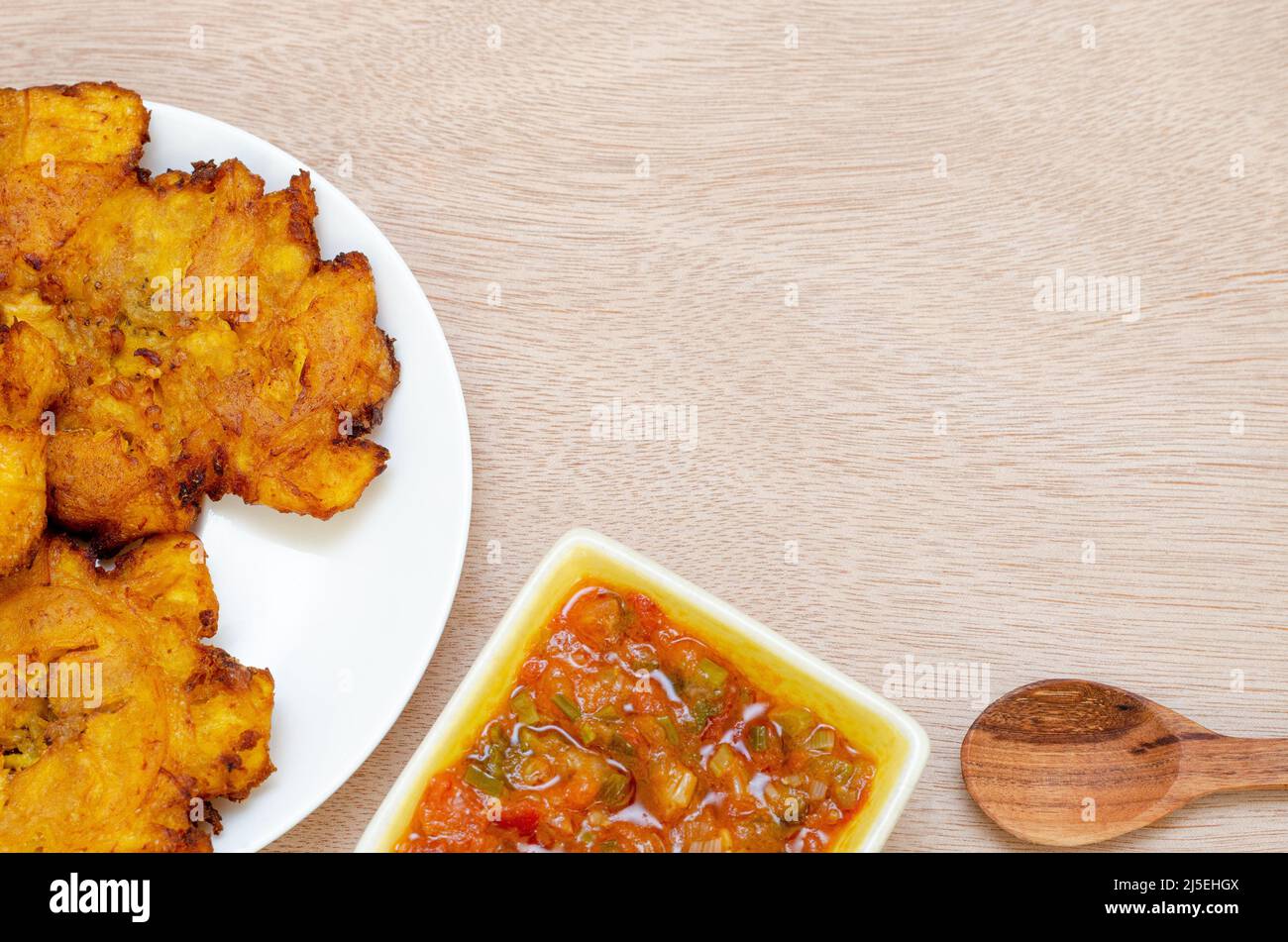 Patacones or fried tostones of green or ripe plantain, crispy, with ...