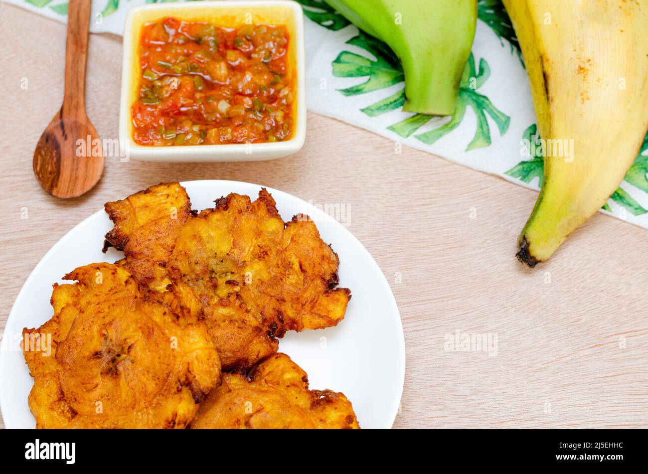 Patacones or fried tostones of green or ripe plantain, crispy, with ...