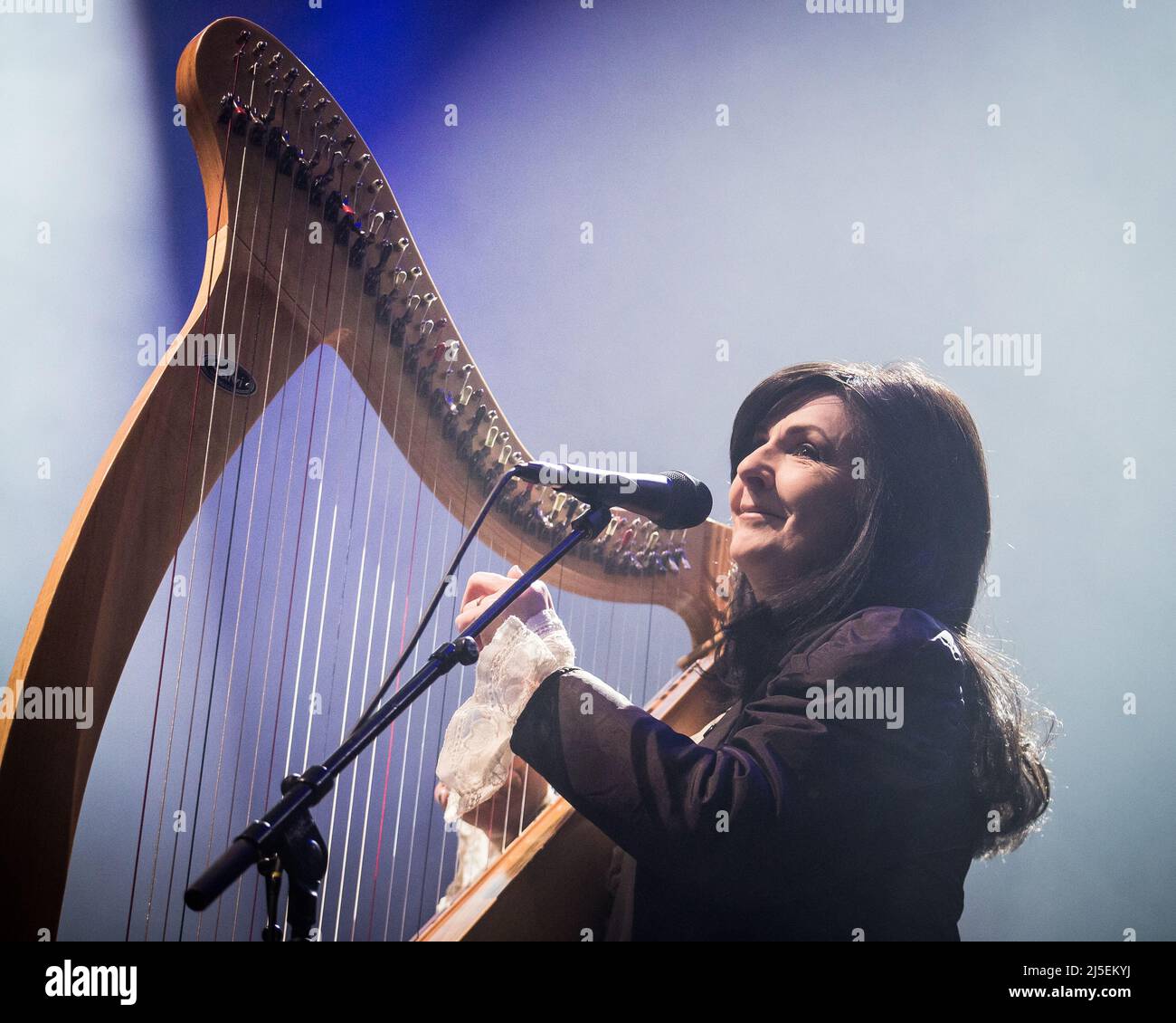 Moya Brennan of Irish band Clannad performing on stage live with a harp ...