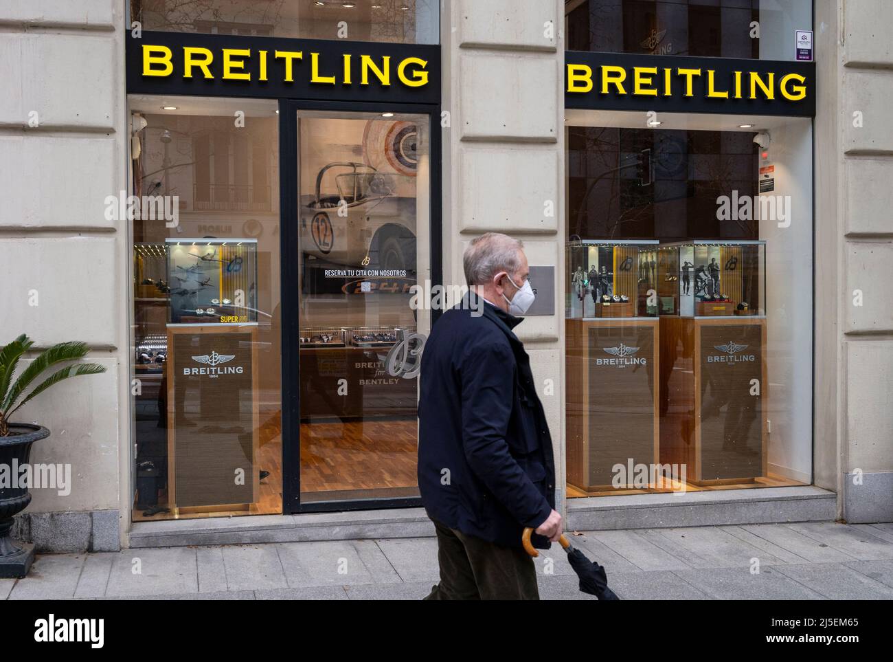 A pedestrian walks past the Swiss luxury watchmaker brand Breitling ...