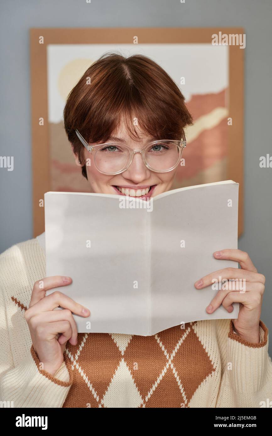 Cheerful girl open book sitting hi-res stock photography and images - Alamy