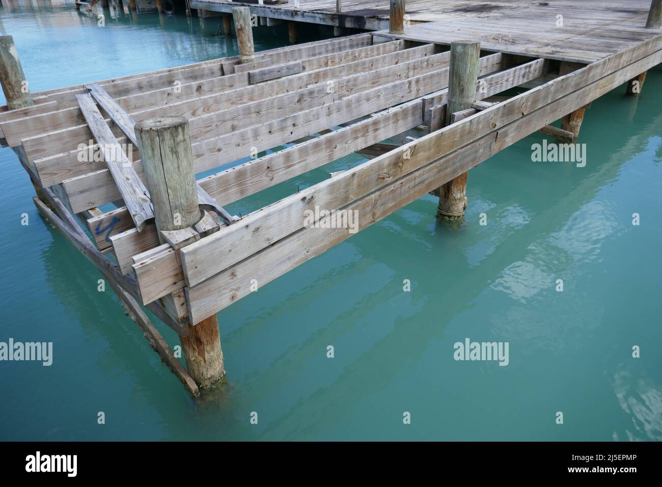 Unfinished wooden boat dock over ocean water Stock Photo - Alamy