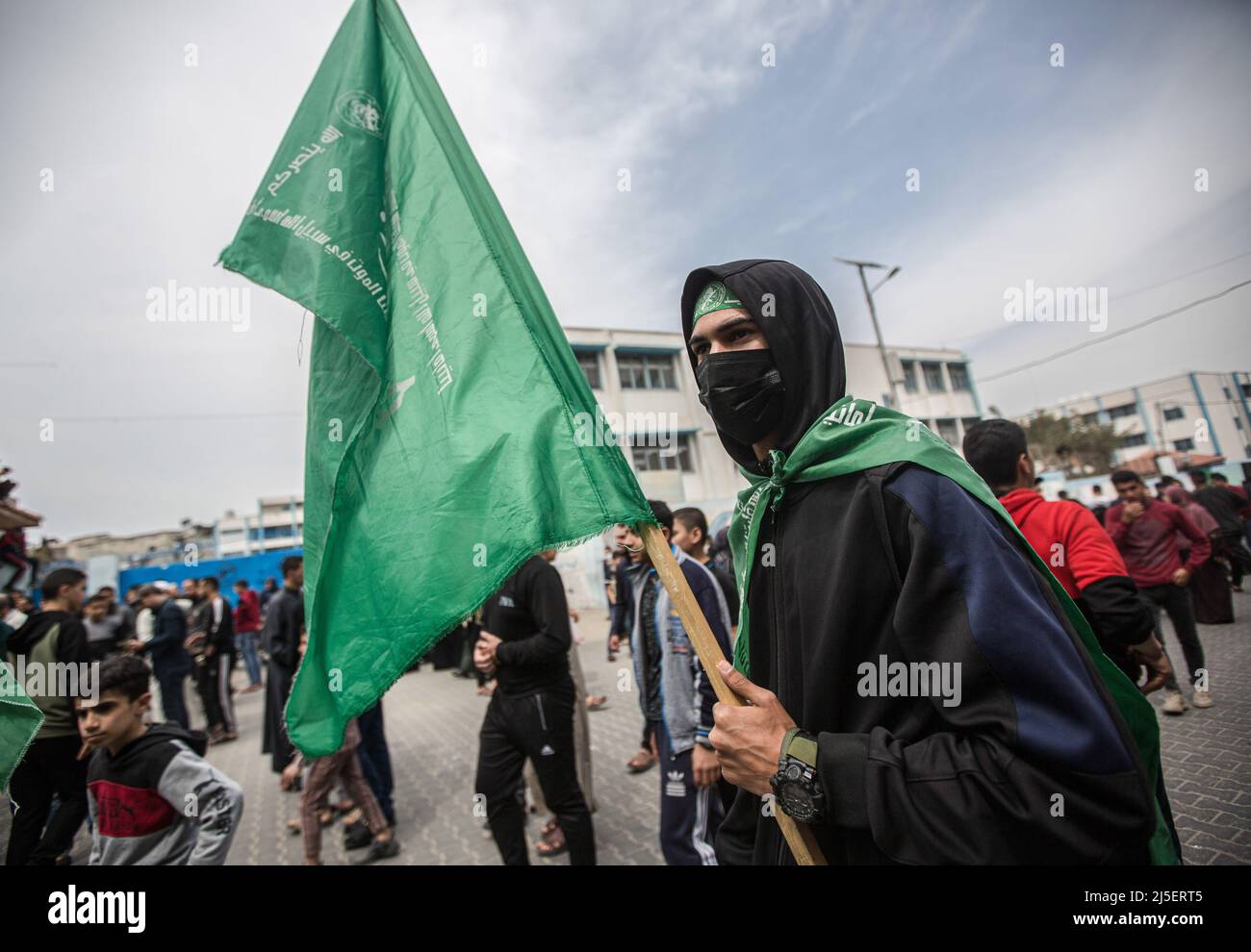 A Palestinian supporter of the Islamic movement Hamas holds a flag ...