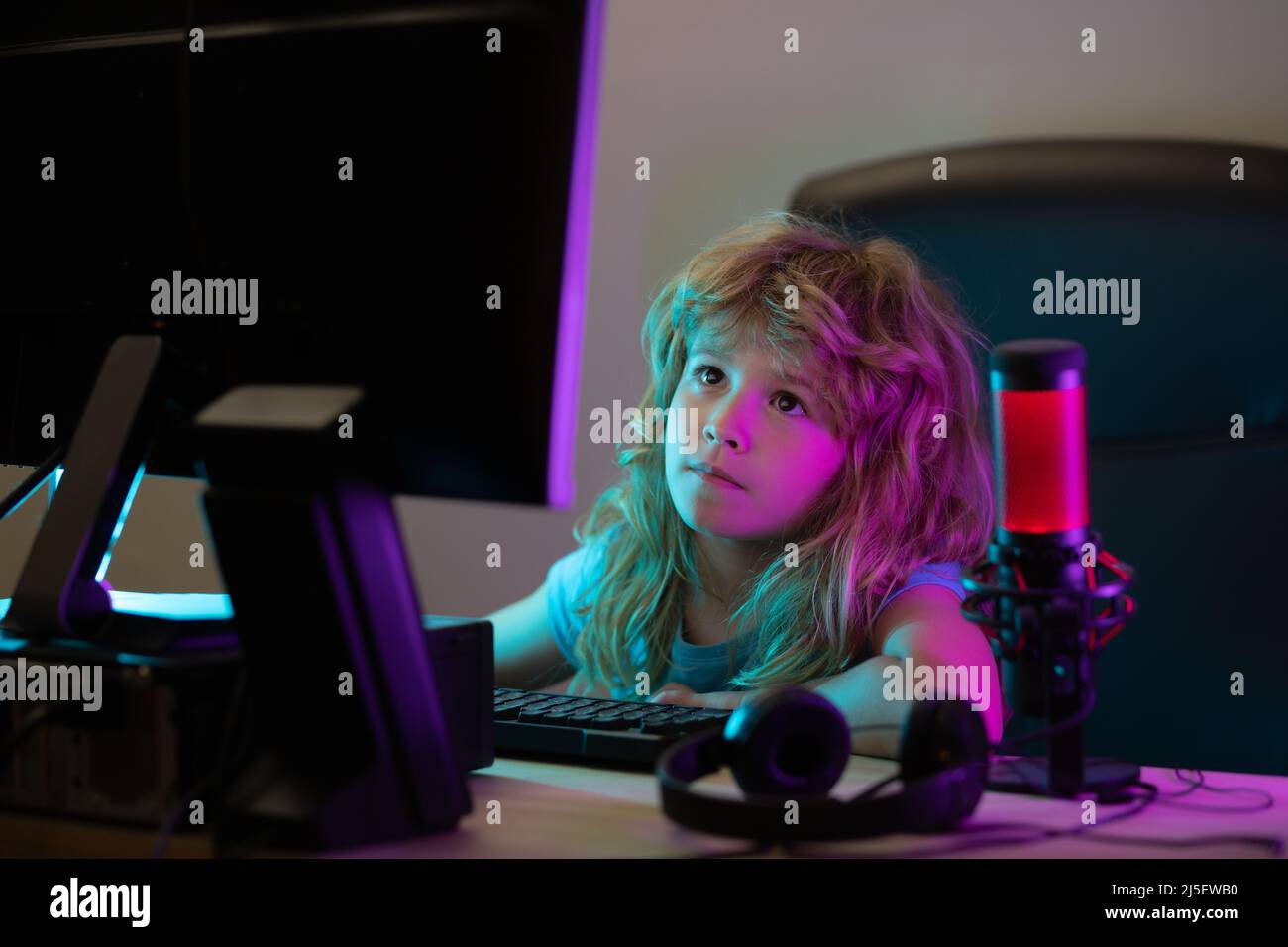 Little child blogger. Kid Boy recording a podcast on computer. School ...