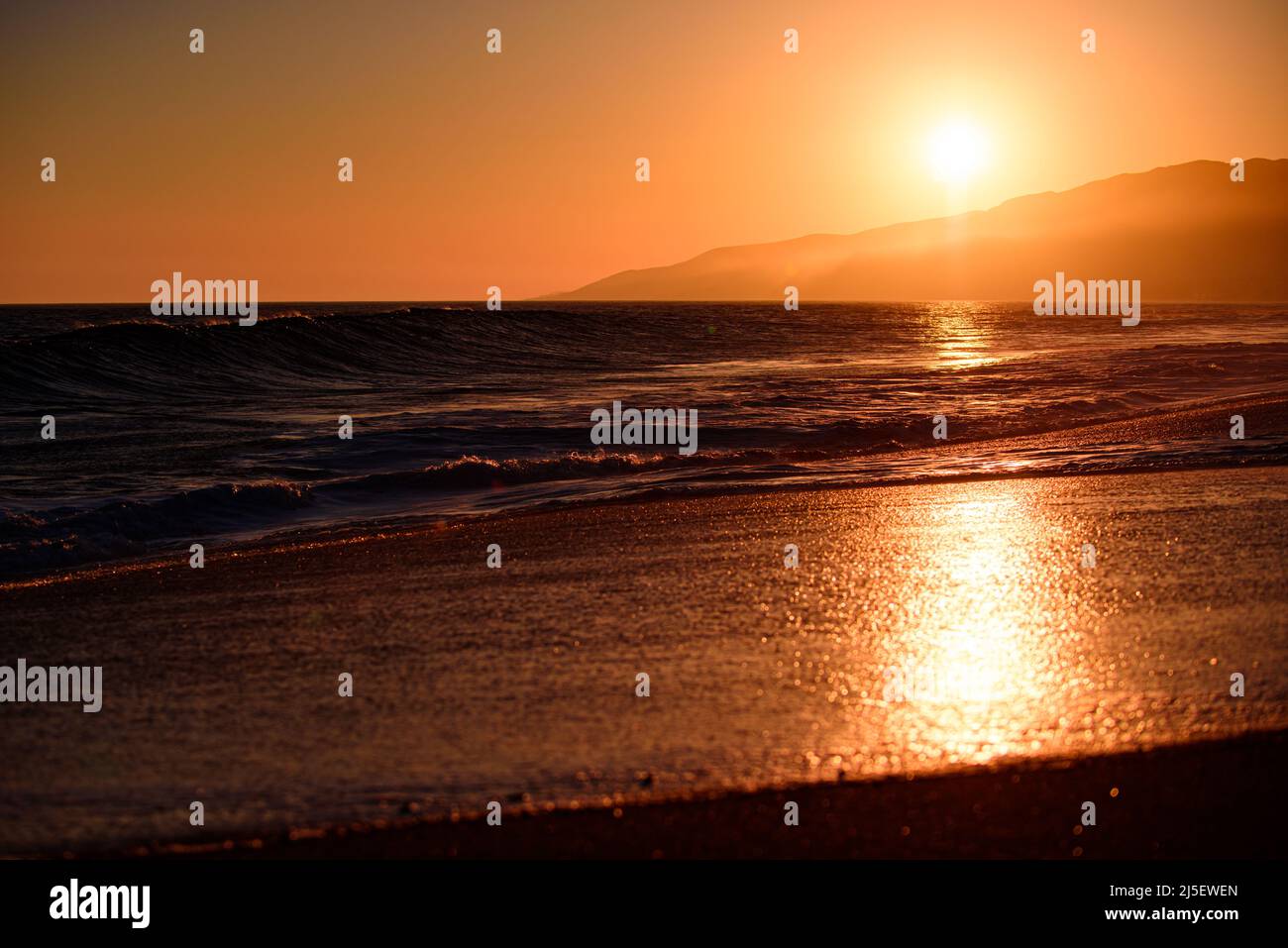 Tropical beach with smooth wave and sunset sky abstract background ...