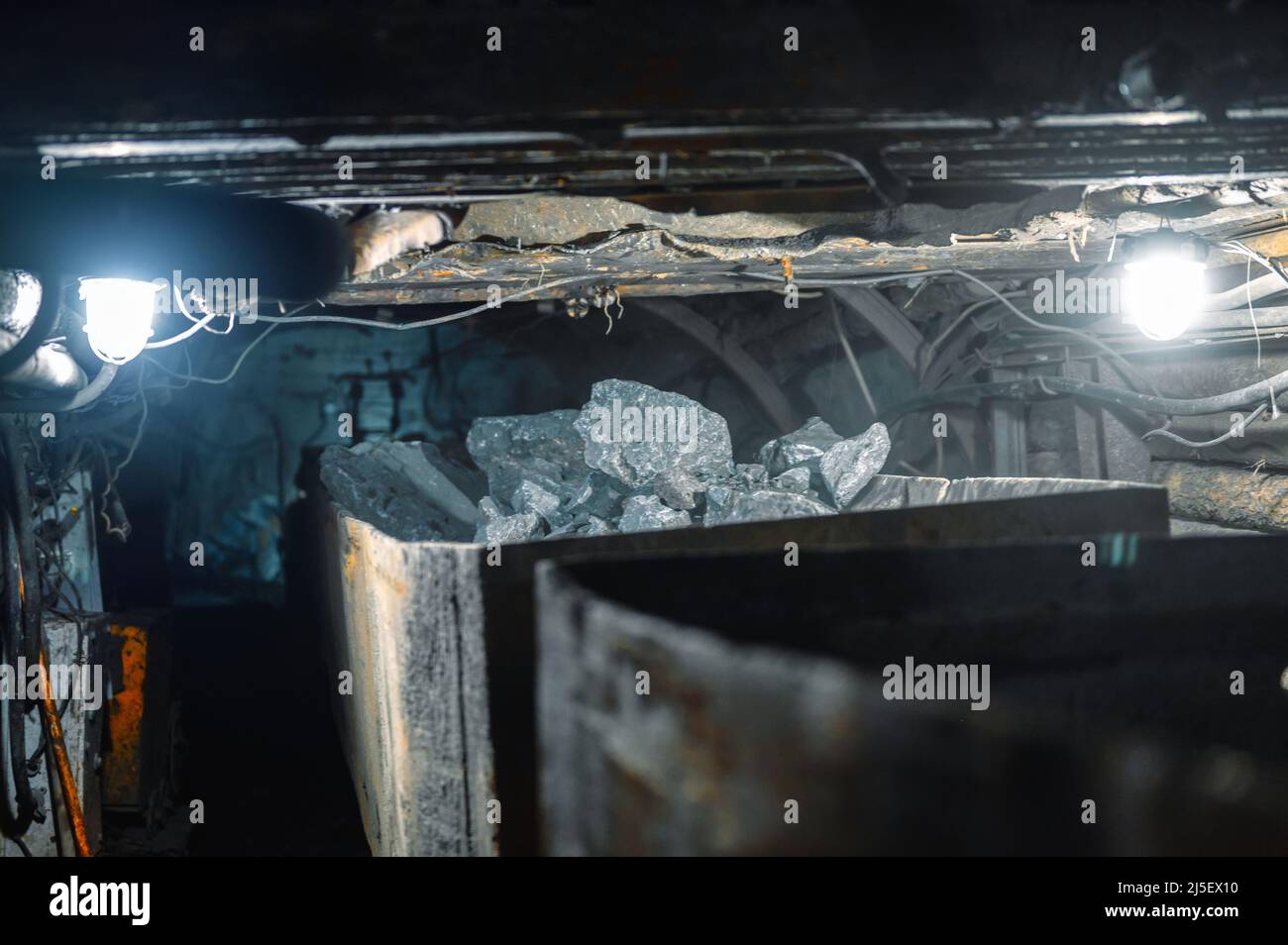 Loading a mine car with ore and stones Stock Photo - Alamy