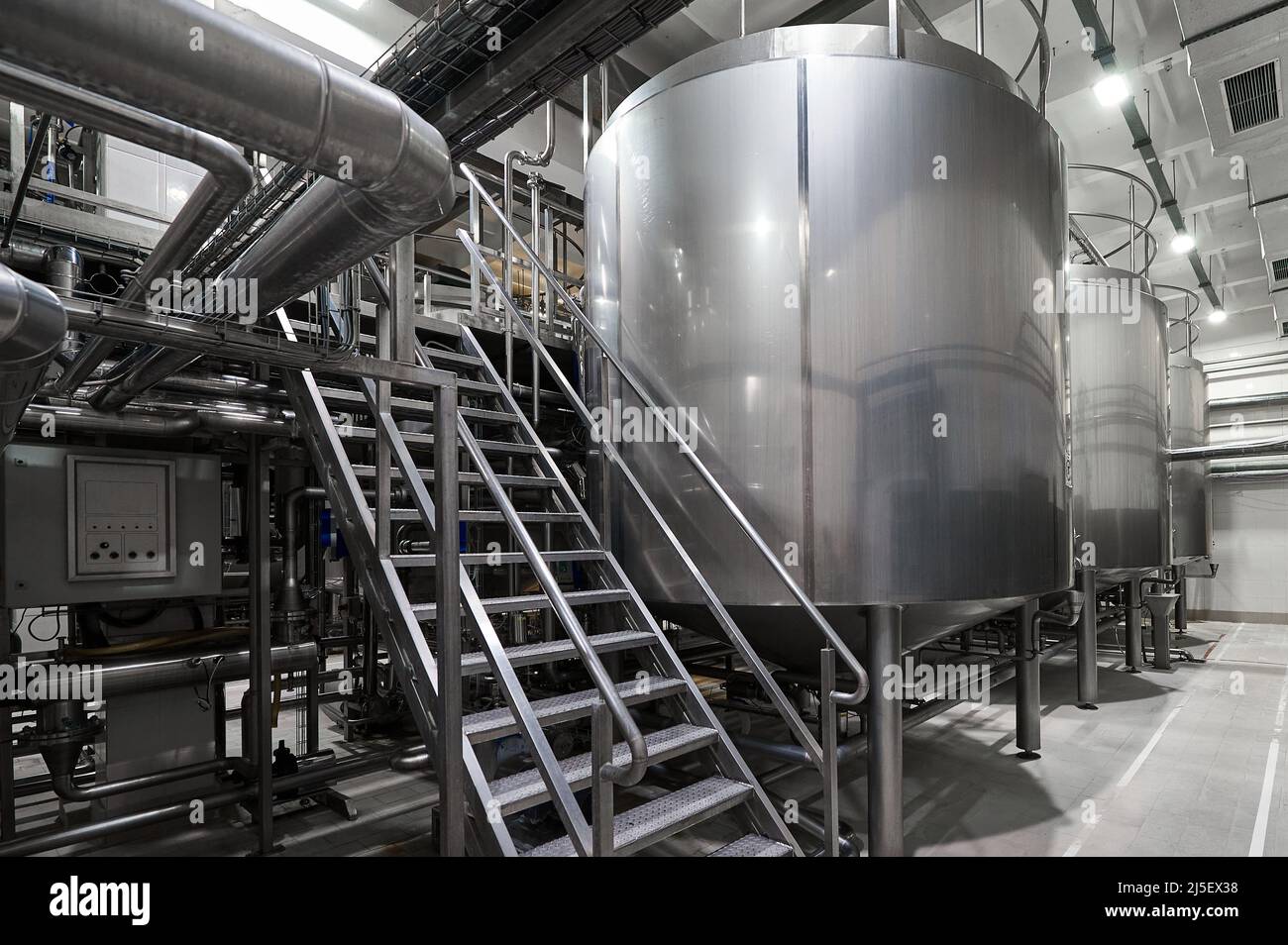 Metal steps near huge tanks for fermented milk products Stock Photo - Alamy