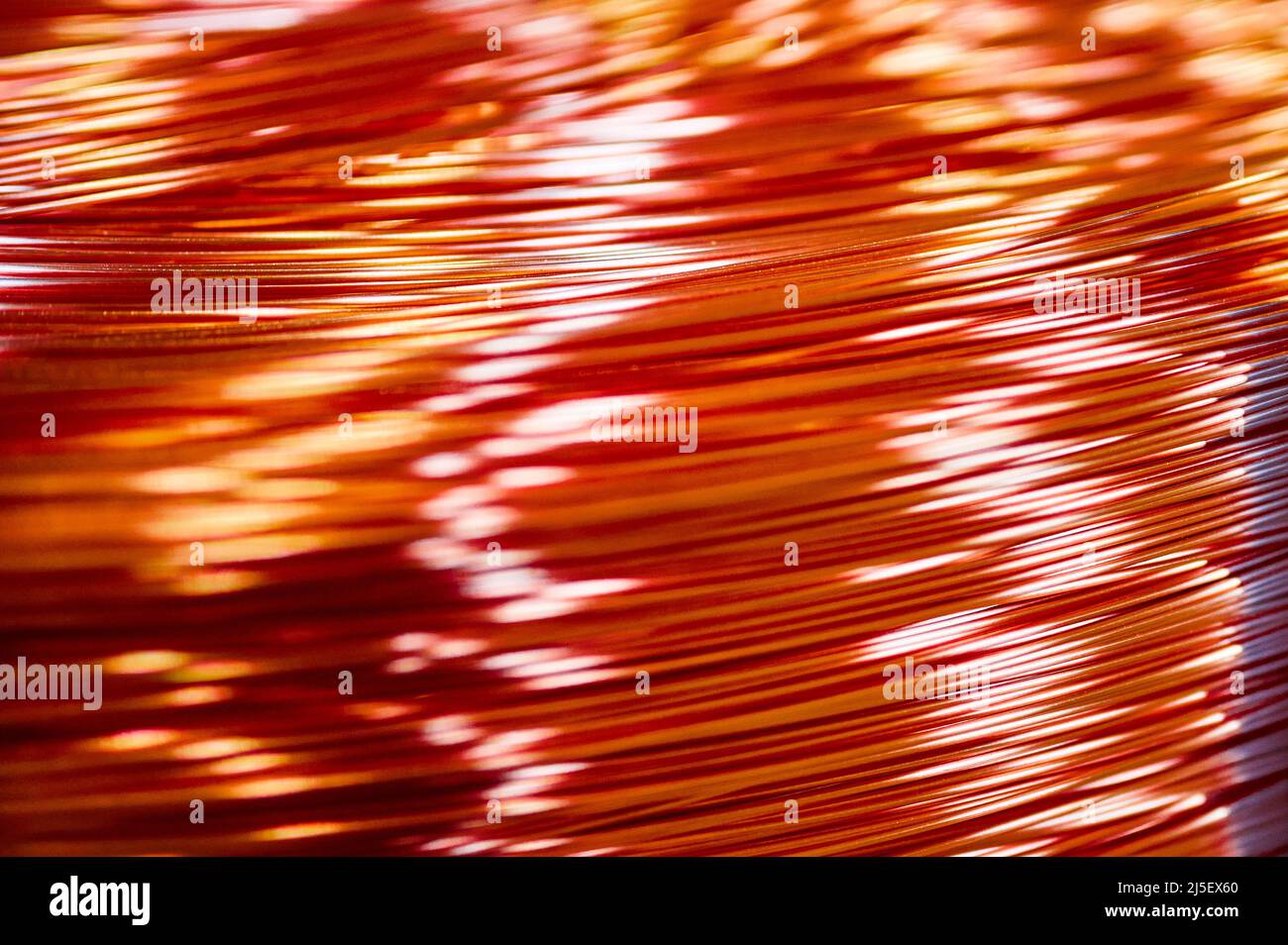 Large bobbin of orange copper wire in light warehouse Stock Photo - Alamy
