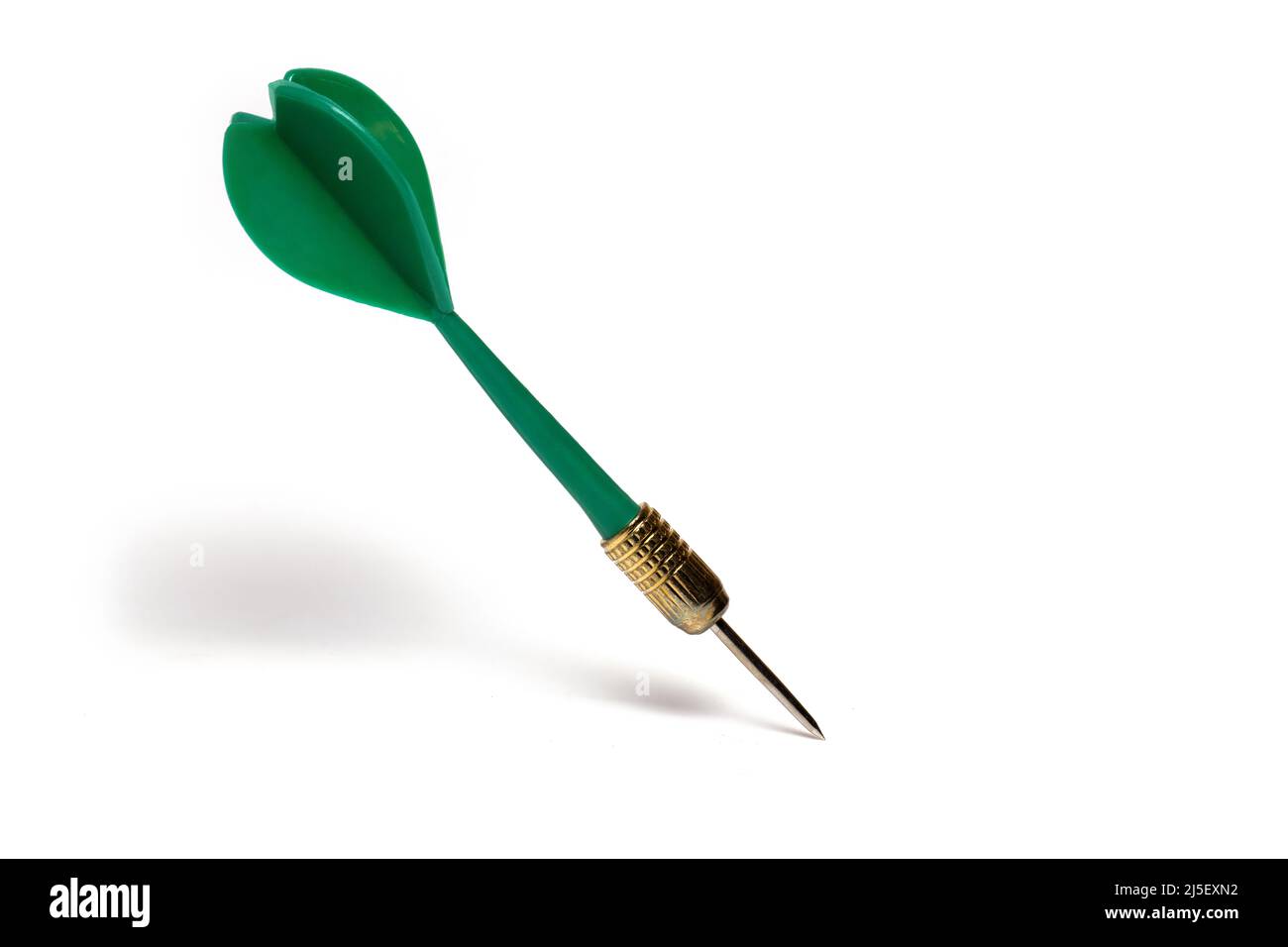 Close up of green plastic dart arrow with pointed metal tip on white ...