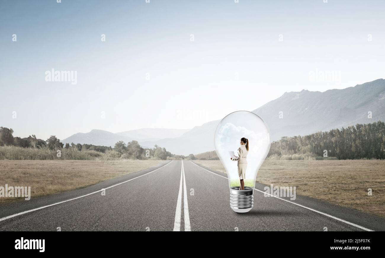 Businesswoman inside light bulb Stock Photo - Alamy