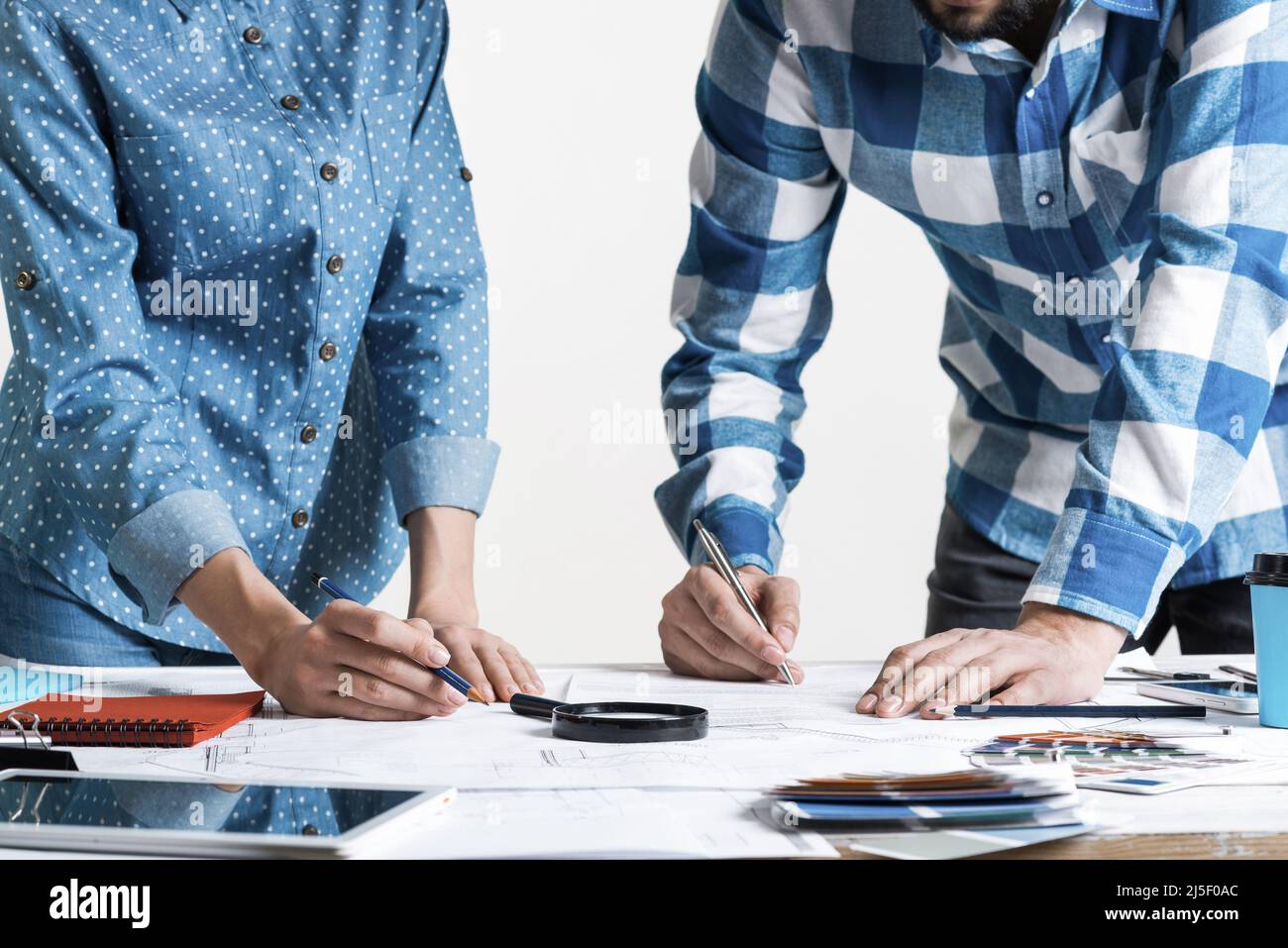 Man writing with pen on technical drawing Stock Photo - Alamy
