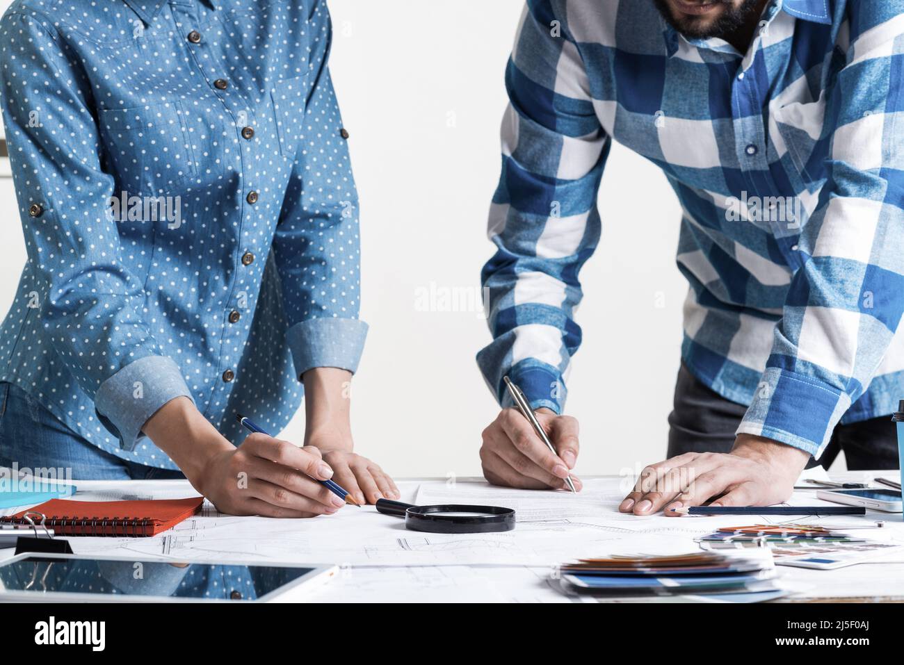 Man carefully studying technical drawing Stock Photo - Alamy