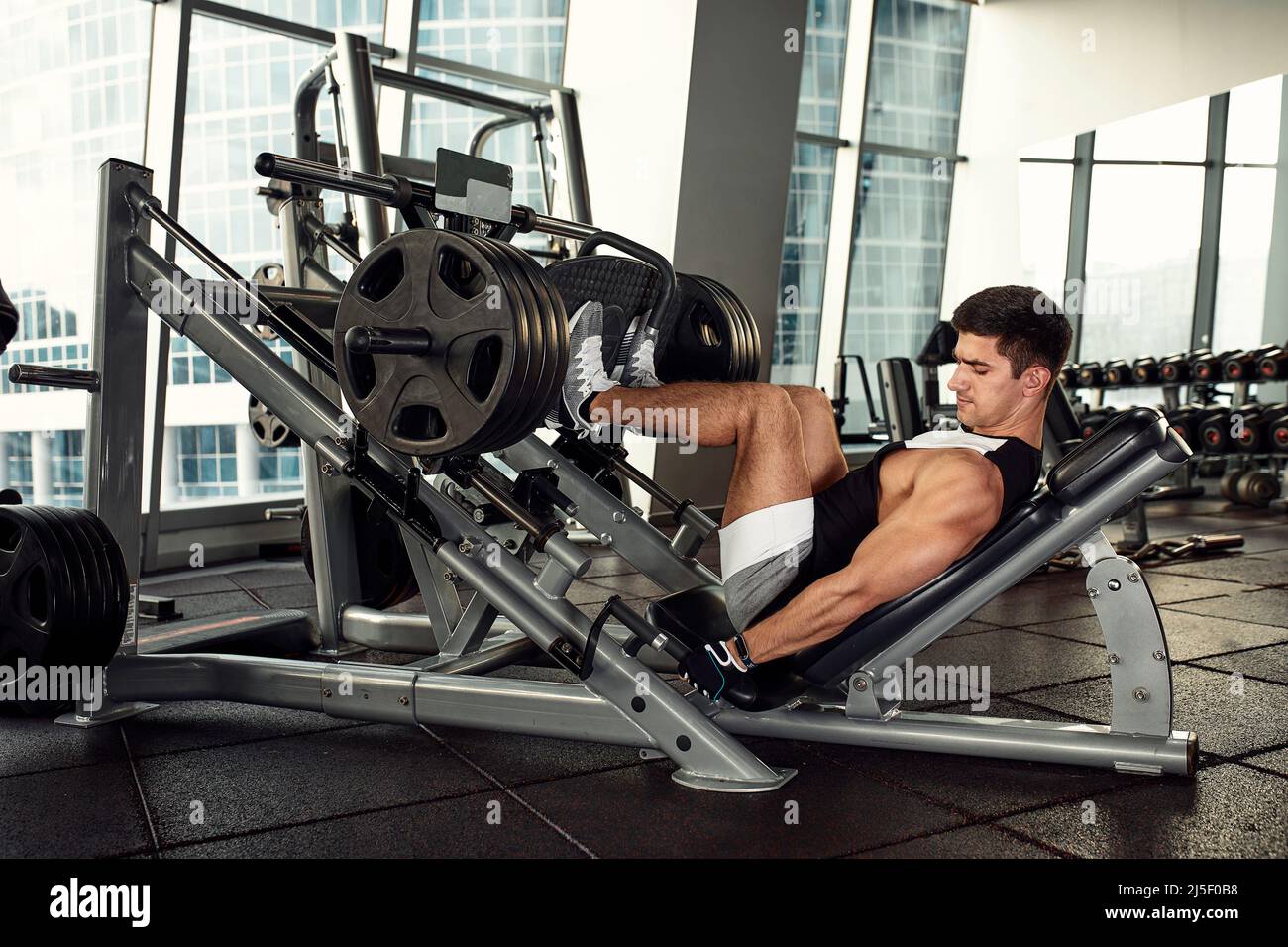 Training legs in the simulator, the athlete works with his legs on the ...