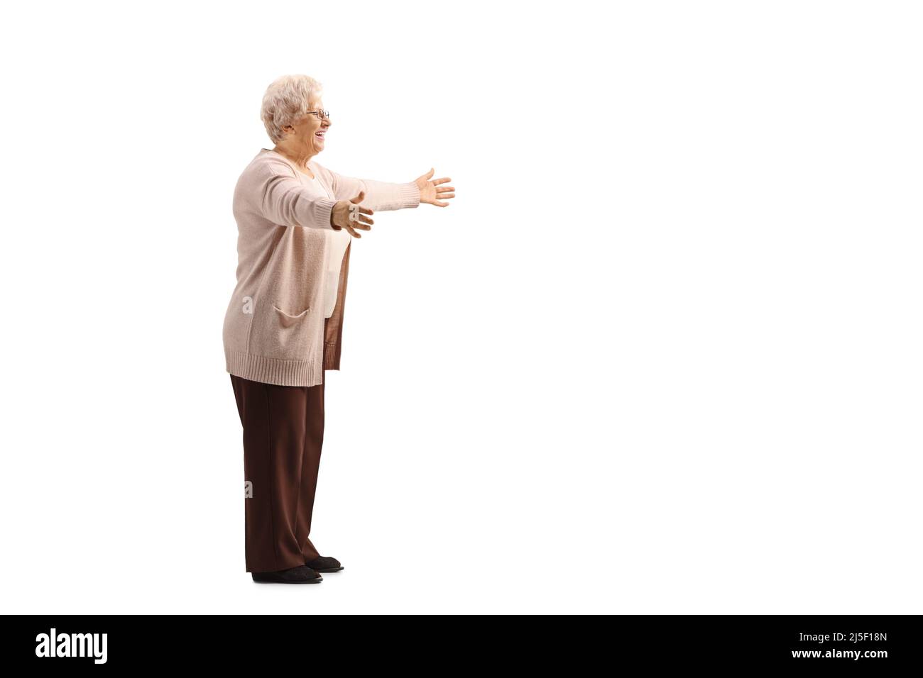 Full length profile shot of a happy elderly woman waiting with arms ...