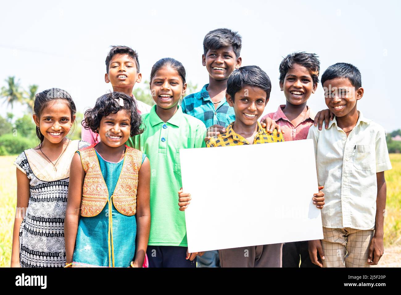 Group of happy smiling Indian village children with one kid holding ...