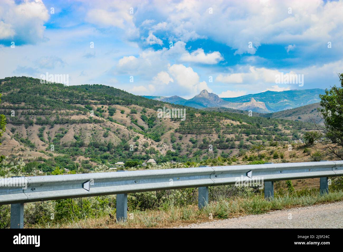 An asphalt road against the backdrop of mountains and a stunningly ...