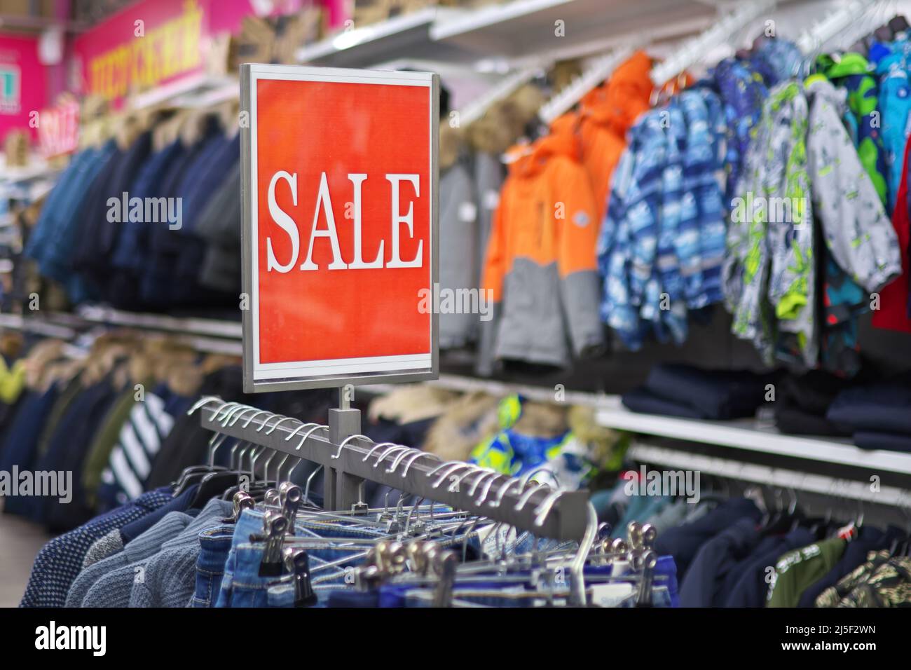 Sale sign notice into a clothes store. Shopping mall advertisement ...