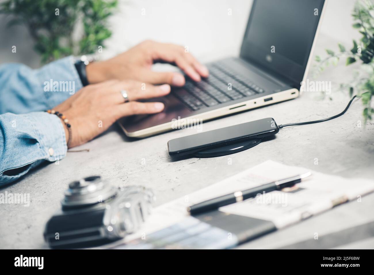 Charging the smartphone with wireless charger on desktop Stock Photo ...