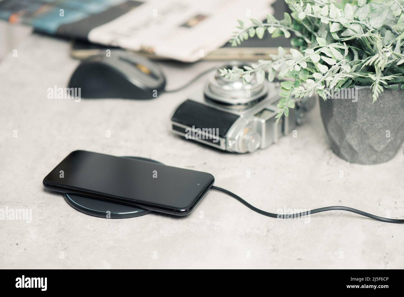 Charging the smartphone with wireless charger on desktop Stock Photo ...