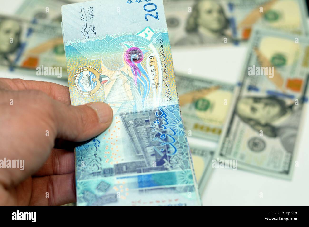 man hand holding a stack of 20 twenty Kuwaiti dinars banknotes money ...