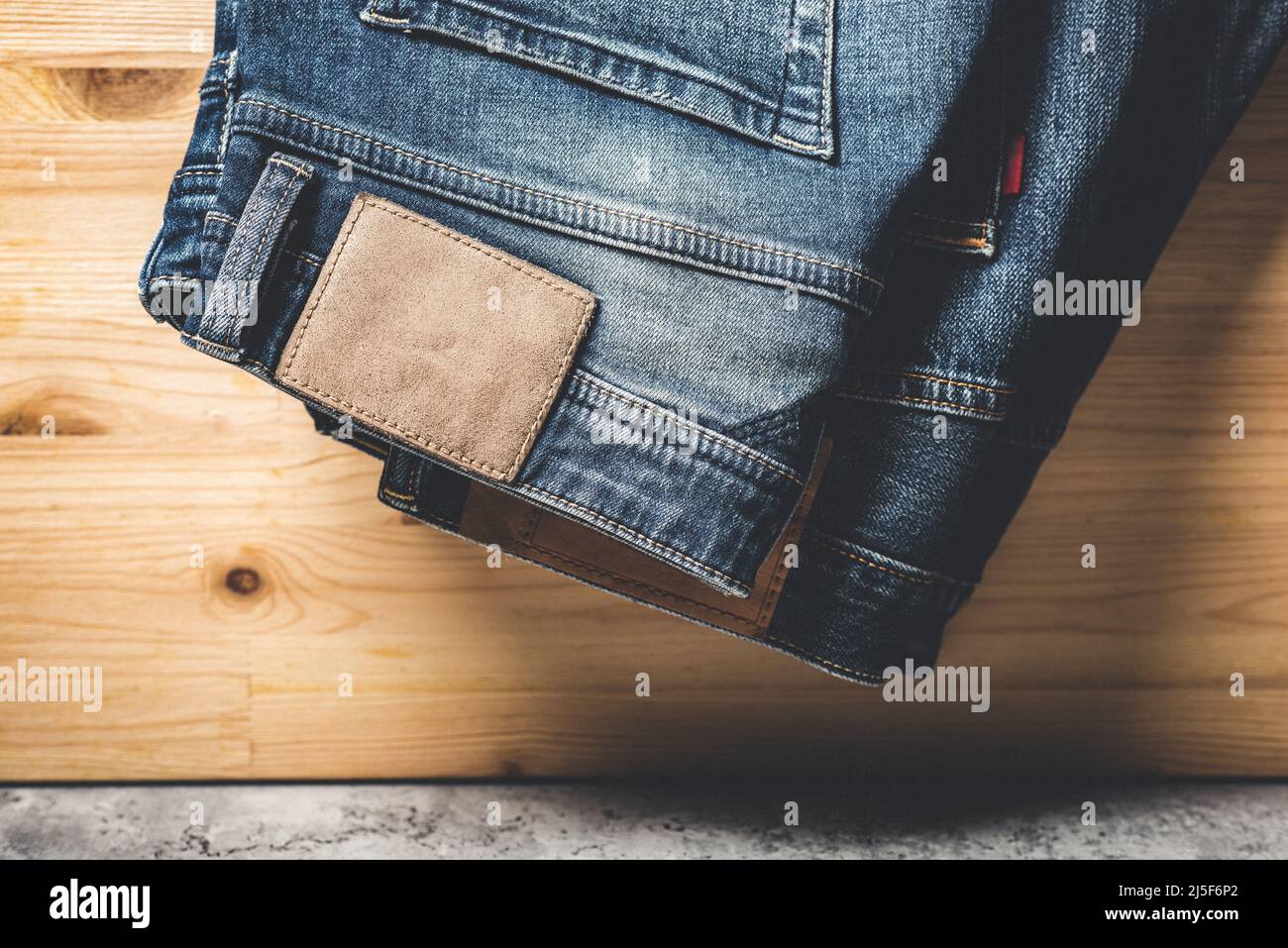many blue jeans on concrete background. men fashion denim jeans Stock ...