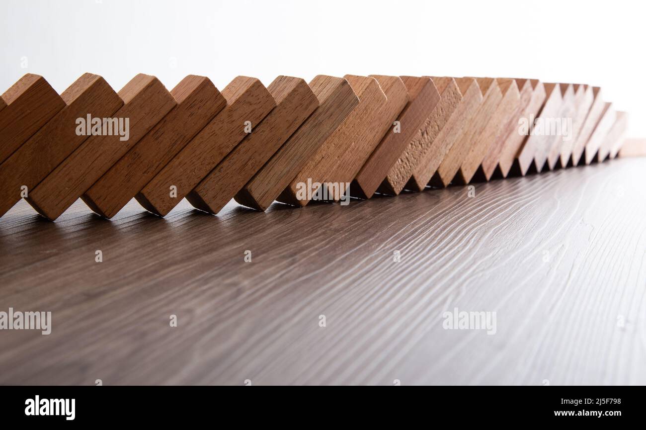 A lot wooden block standing in a line. Domino Effect Concept Stock ...