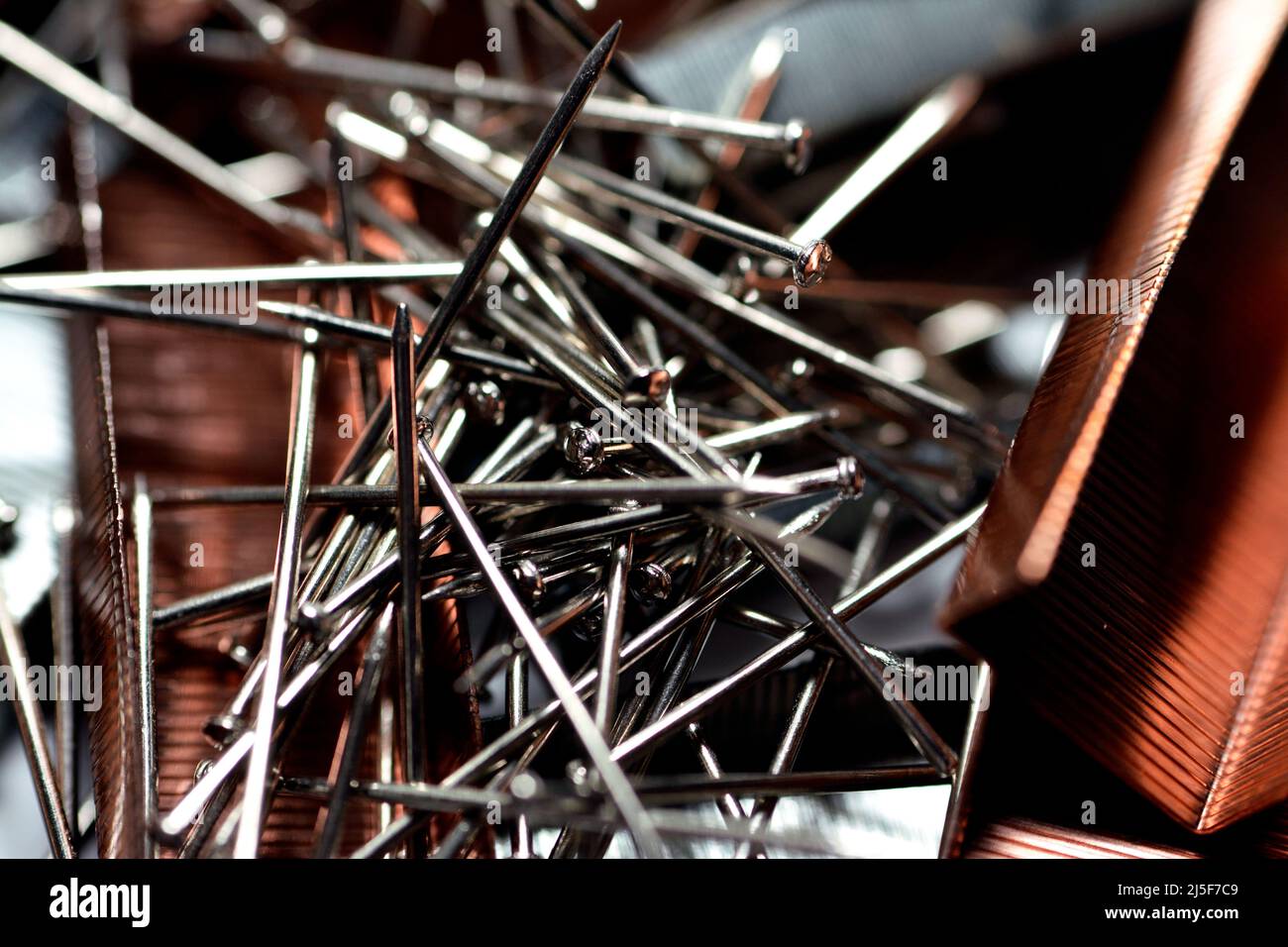 A pile of stapler staples and nickel plated steel pins, stack of paper ...