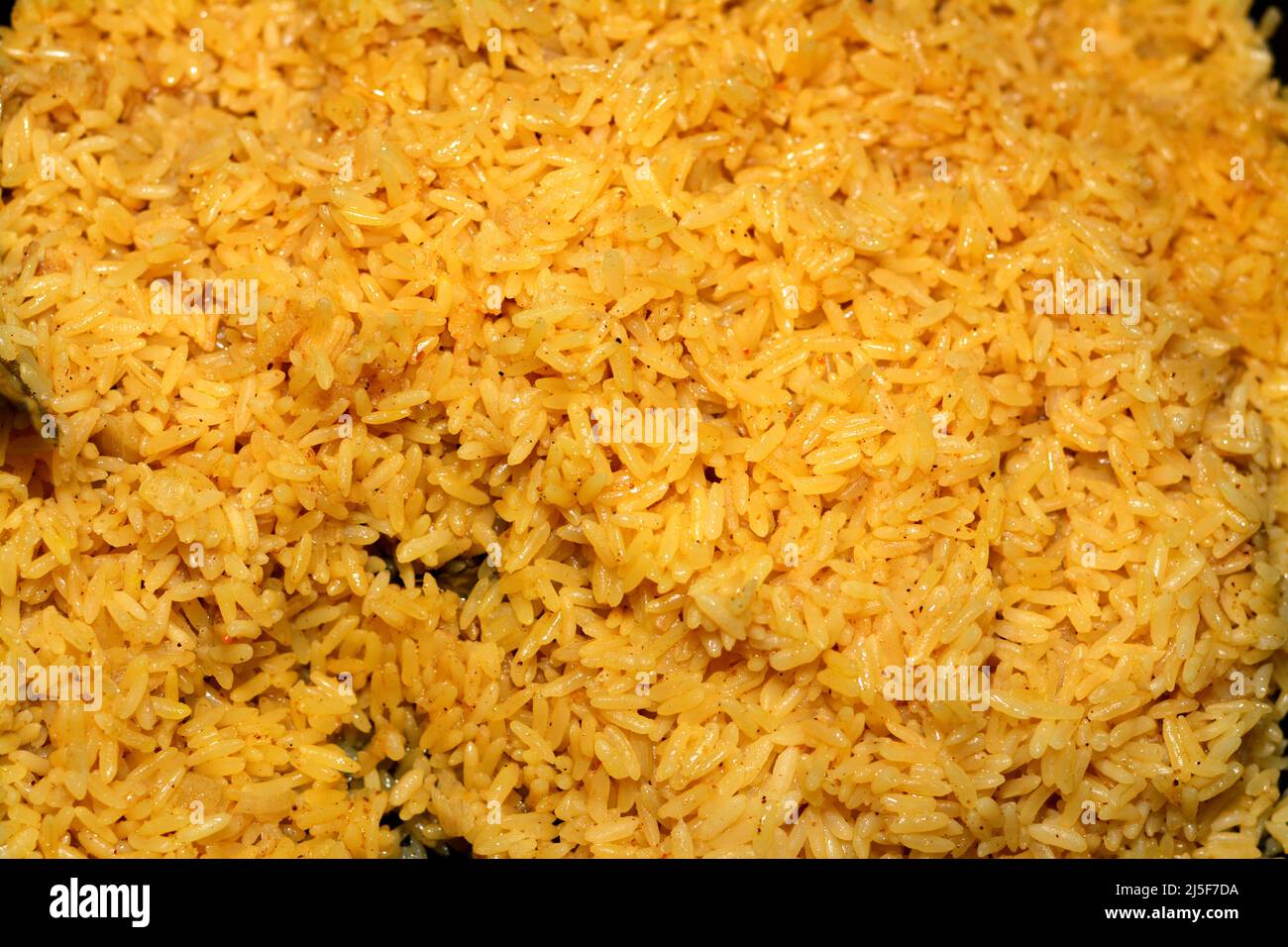 Selective focus of long grain yellow Basmati rice cooked on hot steam ...