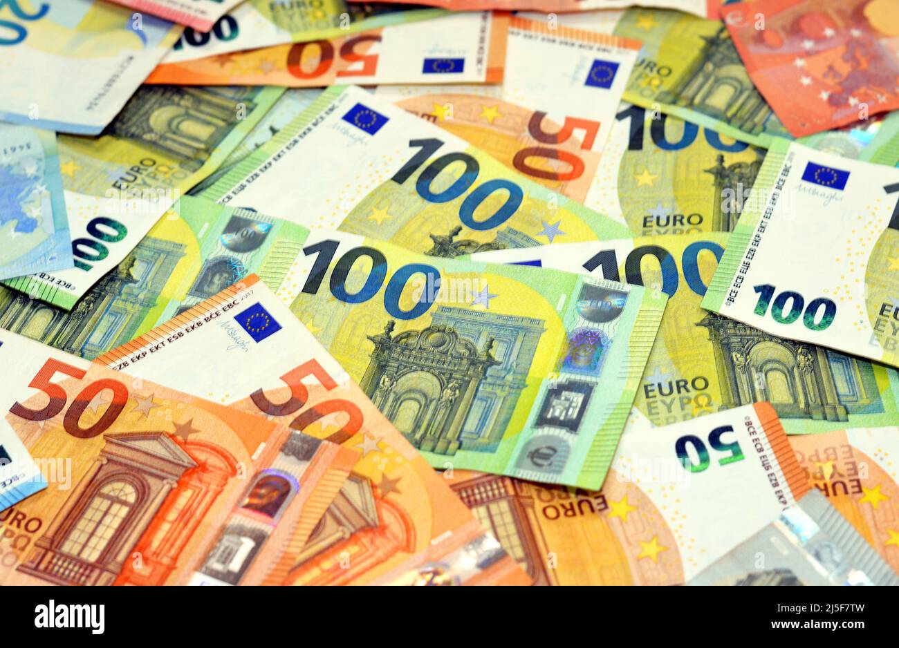 A background of a pile of different euro bill banknotes of 100 one ...