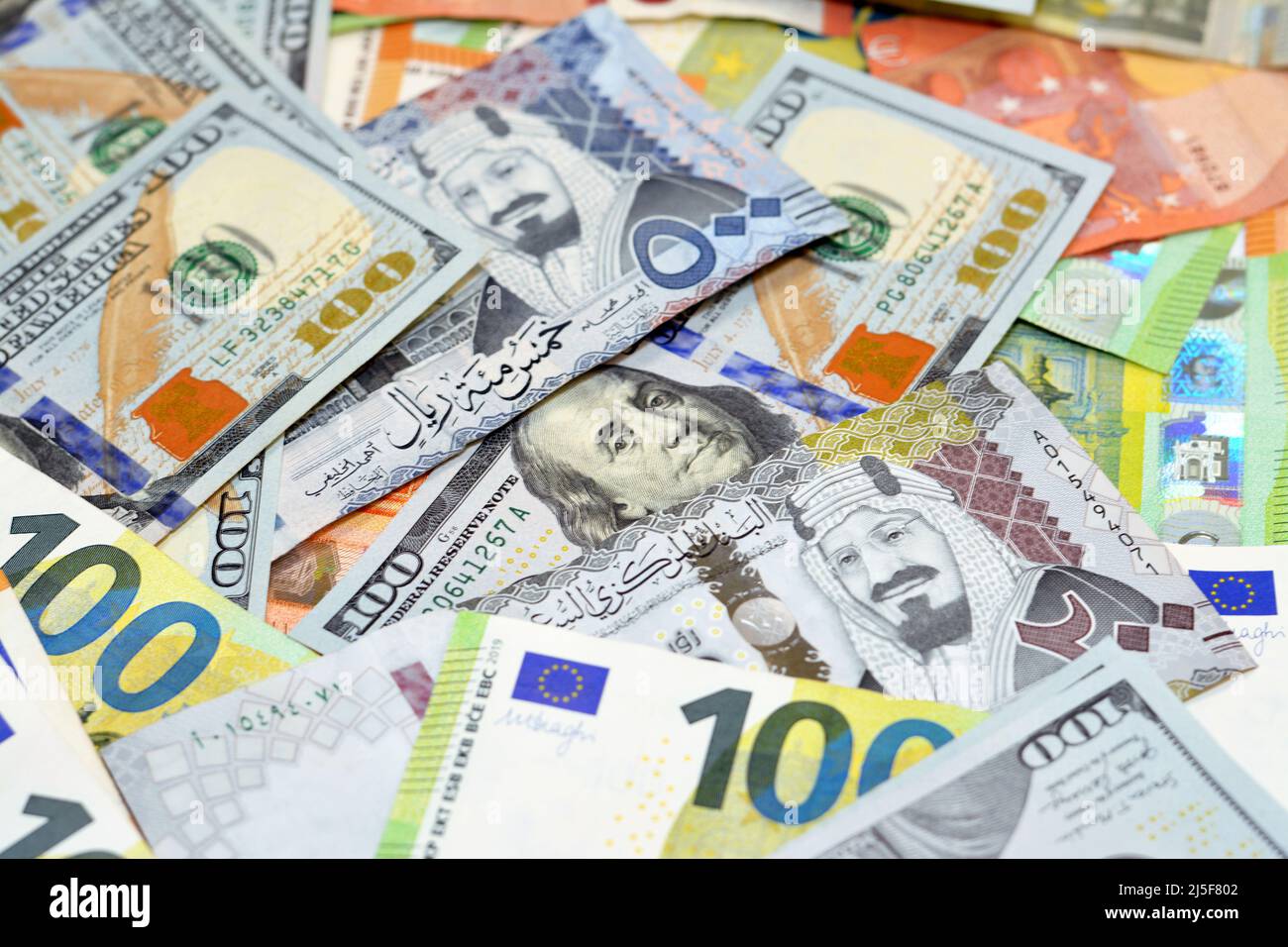 Saudi riyals money with American dollars bills and European euros ...