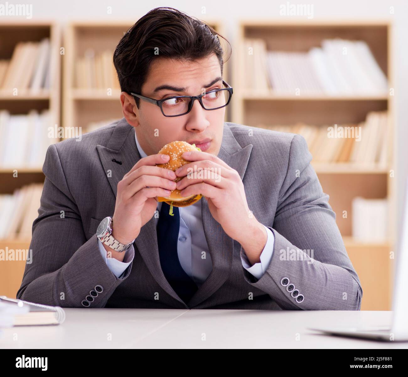 Hungry funny businessman eating junk hi-res stock photography and ...
