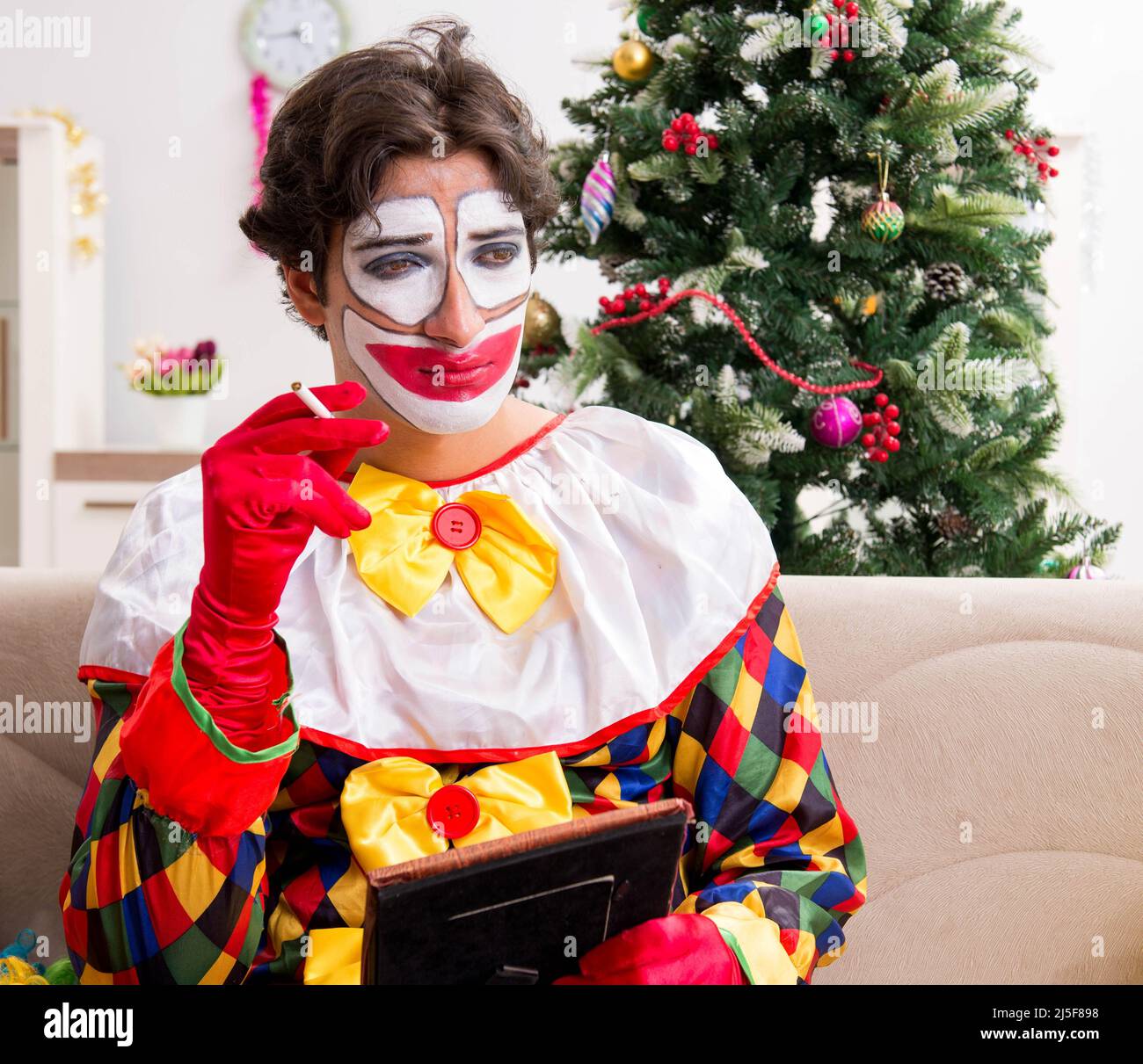 The funny clown in christmas celebration concept Stock Photo - Alamy