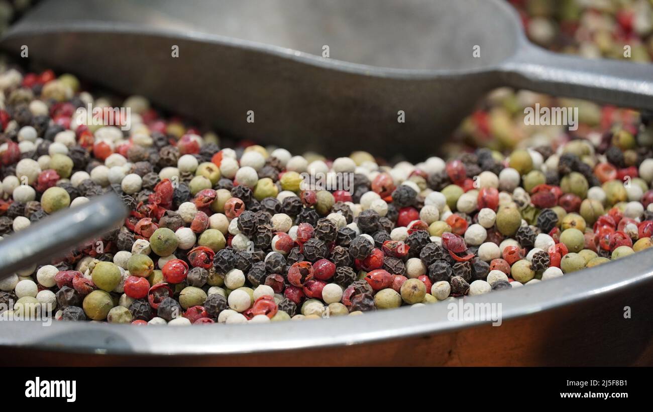 A mix of four types of pepper grain: black, white, pink, green for sale ...