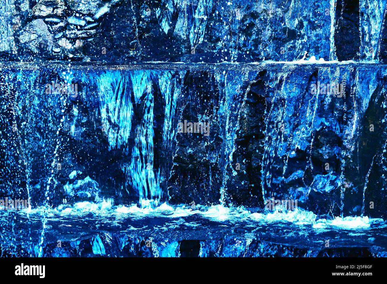 Pure mineral blue water flows over stepped mountain stones Stock Photo ...
