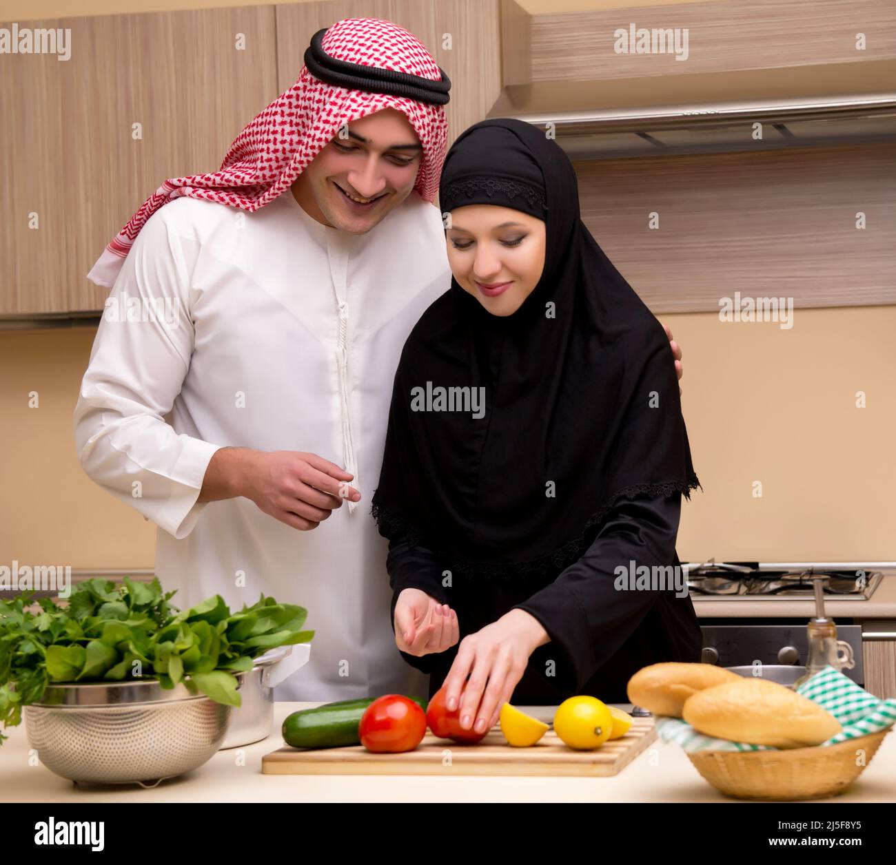The young arab family in the kitchen Stock Photo - Alamy