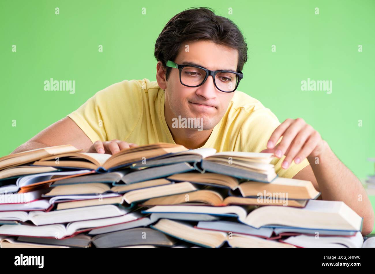 The student with too many books to read before exam Stock Photo - Alamy