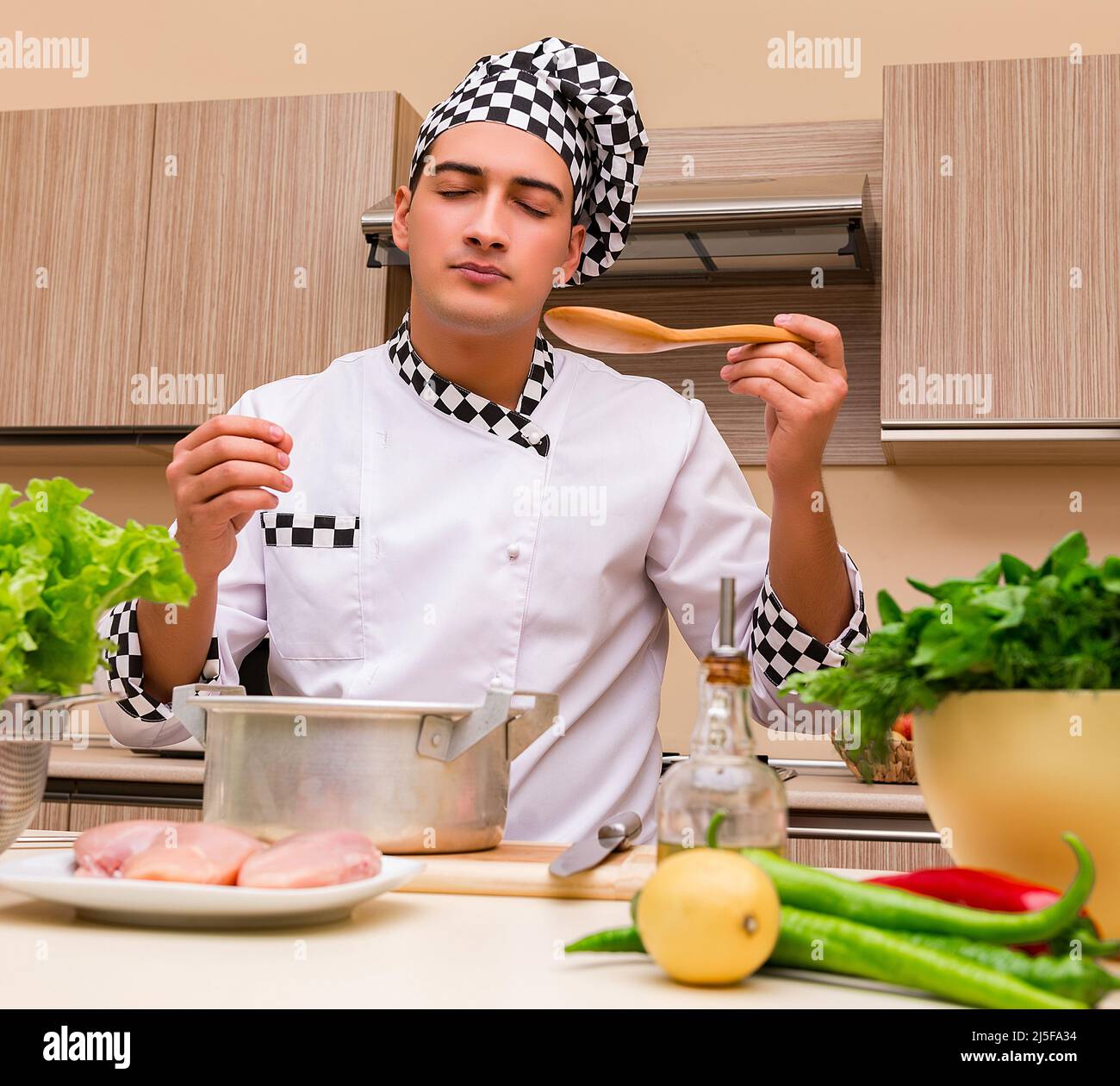 The young chef working in the kitchen Stock Photo - Alamy