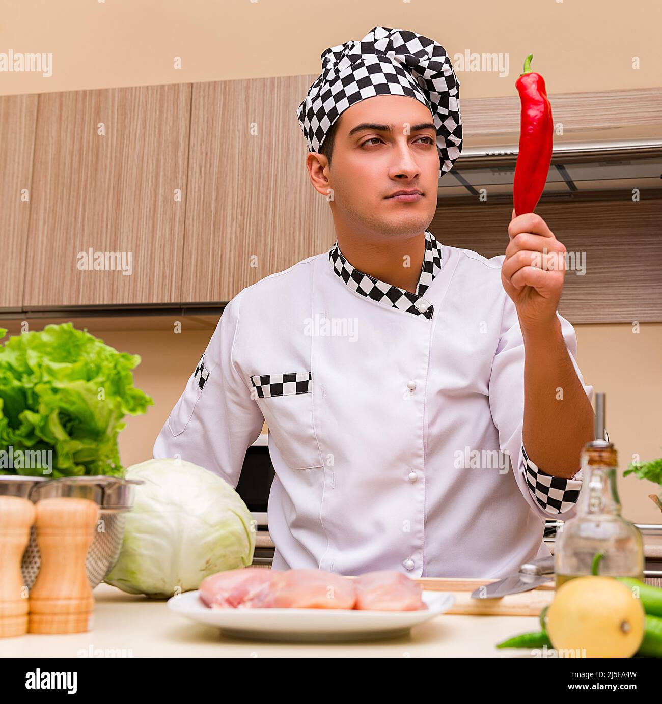 The young chef working in the kitchen Stock Photo - Alamy