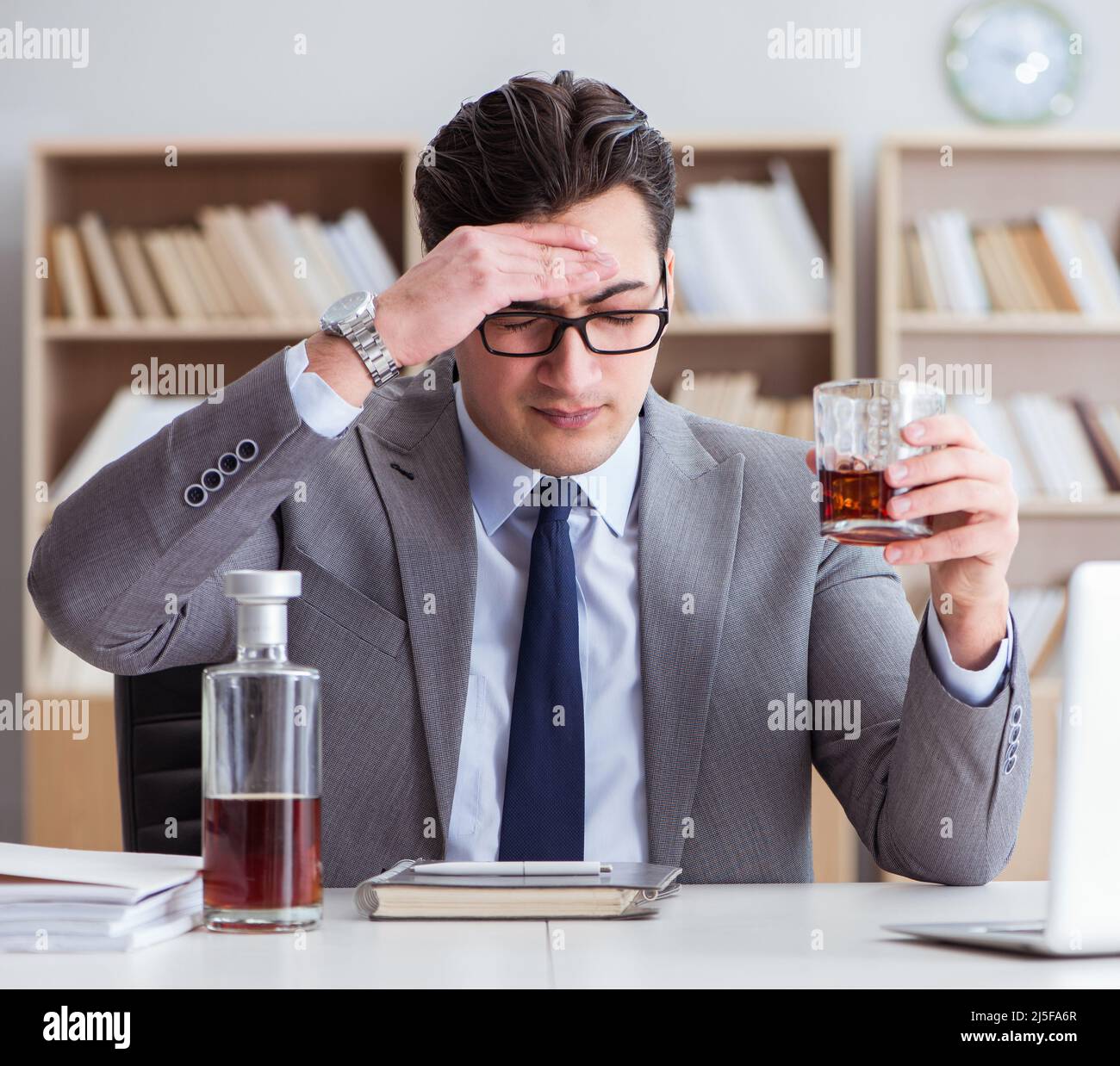 The businessman drinking in the office Stock Photo - Alamy