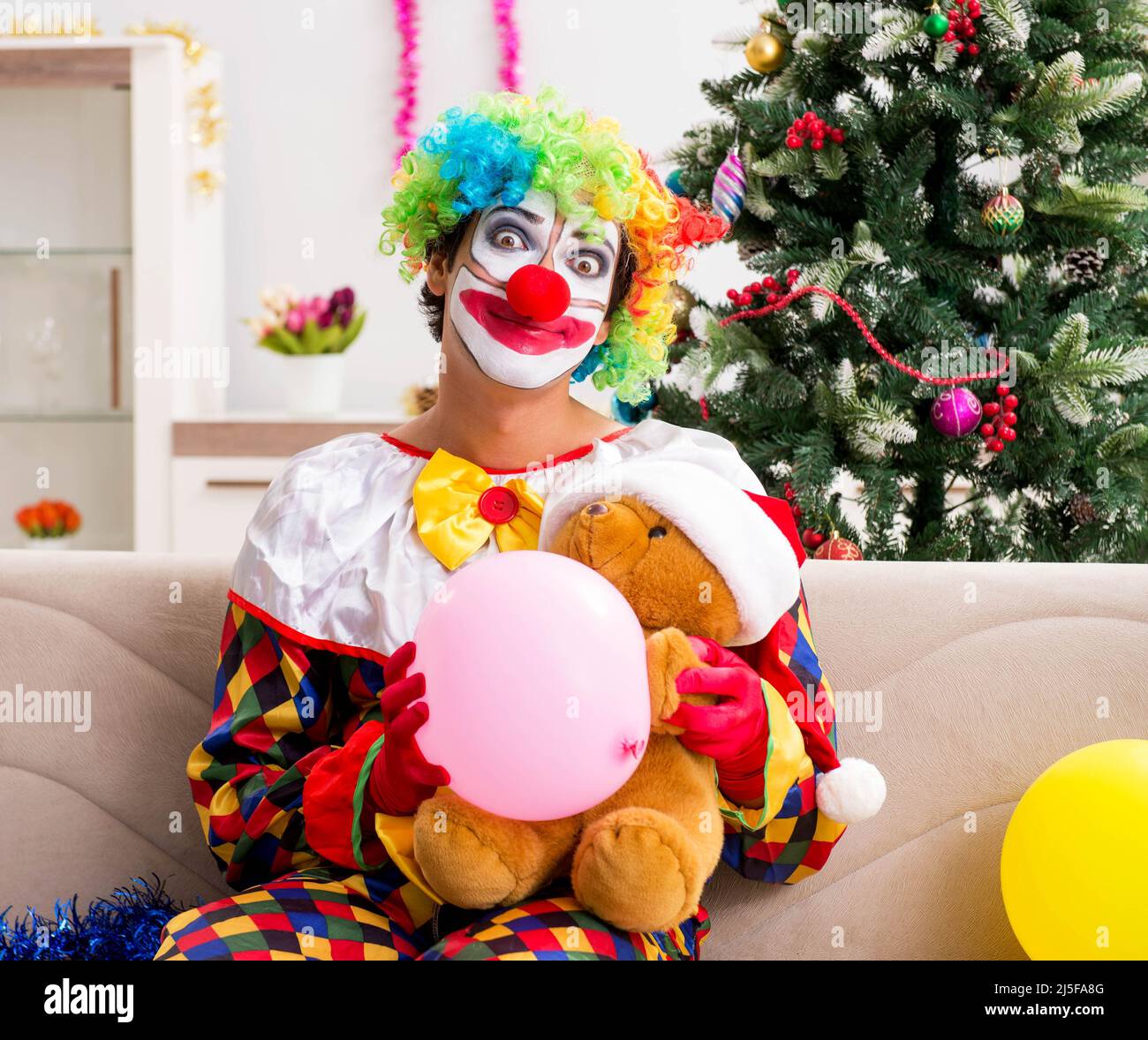 The funny clown in christmas celebration concept Stock Photo - Alamy