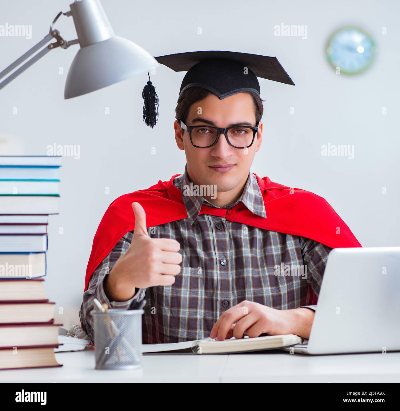 The super hero student with books studying for exams Stock Photo - Alamy