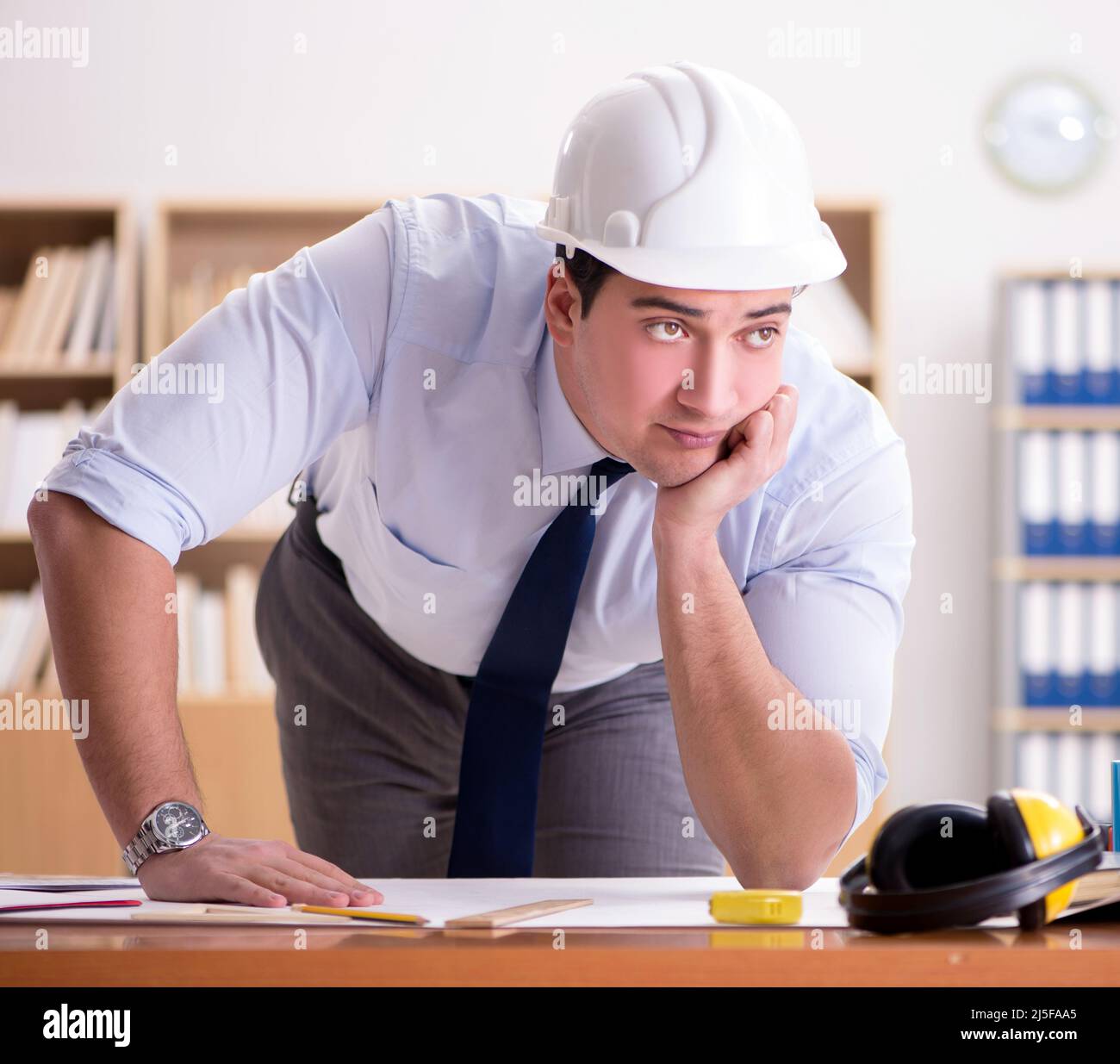 The engineer supervisor working on drawings in the office Stock Photo ...
