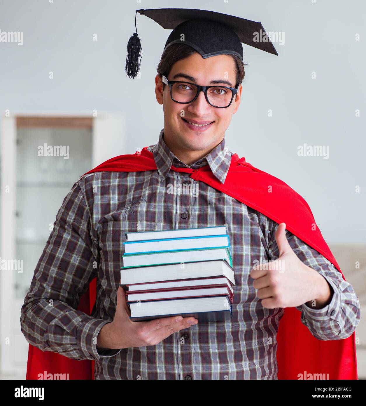 The super hero student with books studying for exams Stock Photo - Alamy