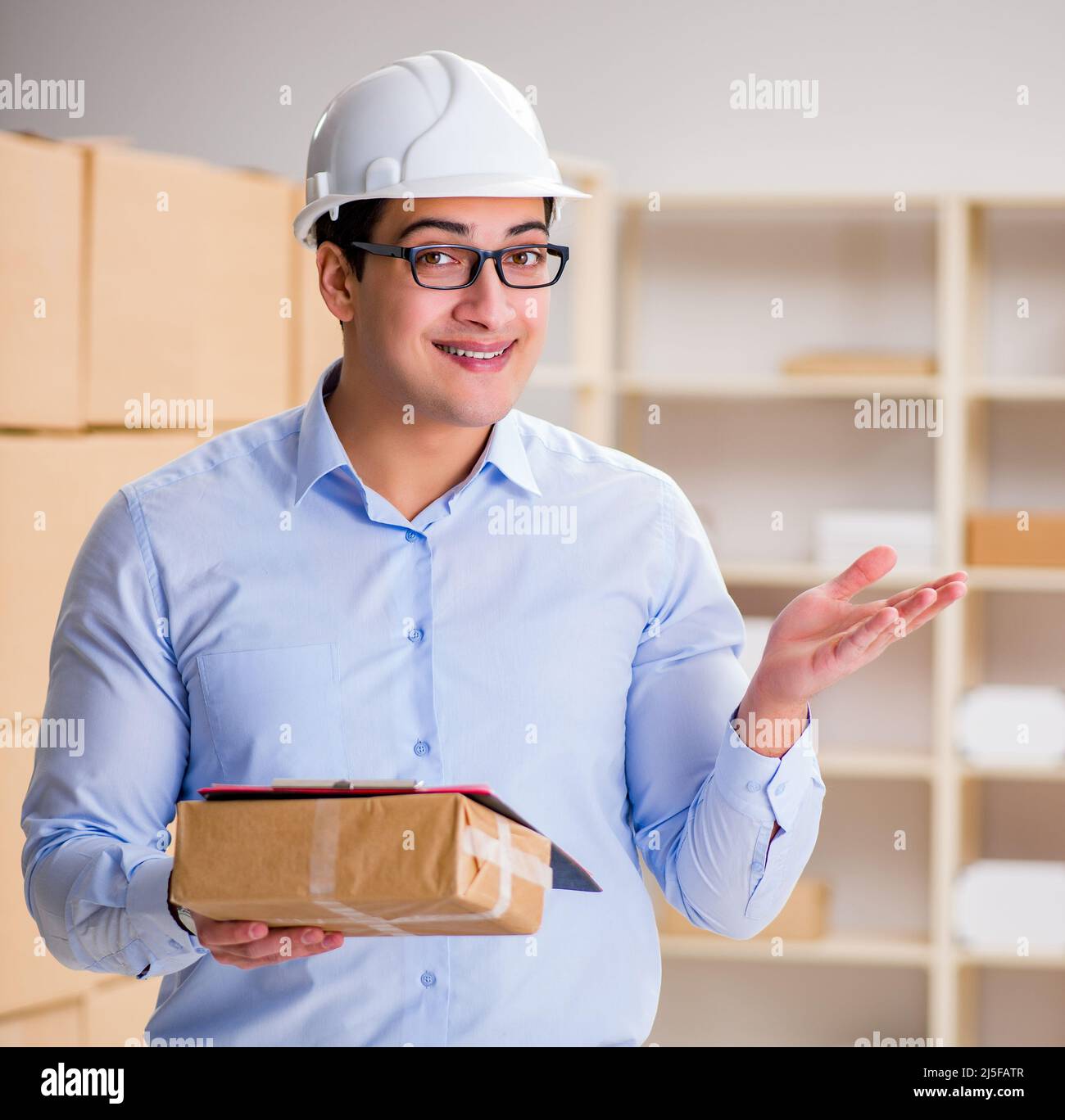 The young worker in the postal office dealing with parcels Stock Photo ...