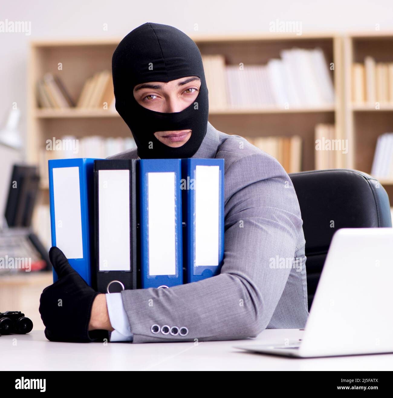 The criminal businessman wearing balaclava in office Stock Photo - Alamy