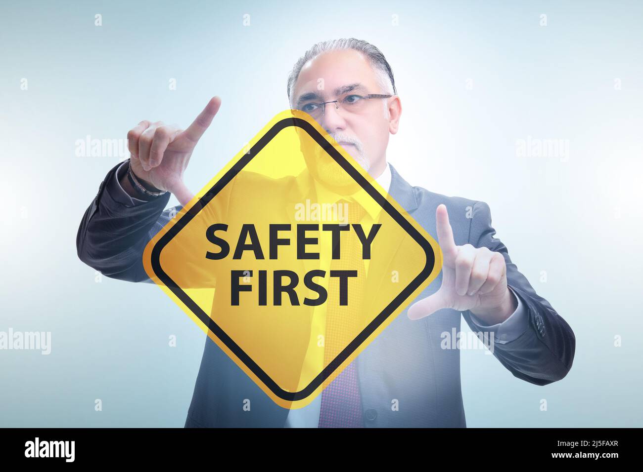 Safety first concept with the businessman Stock Photo - Alamy